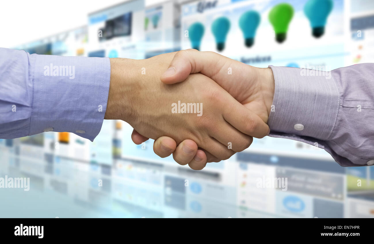 Composite image of hand shake in front of wires Stock Photo - Alamy