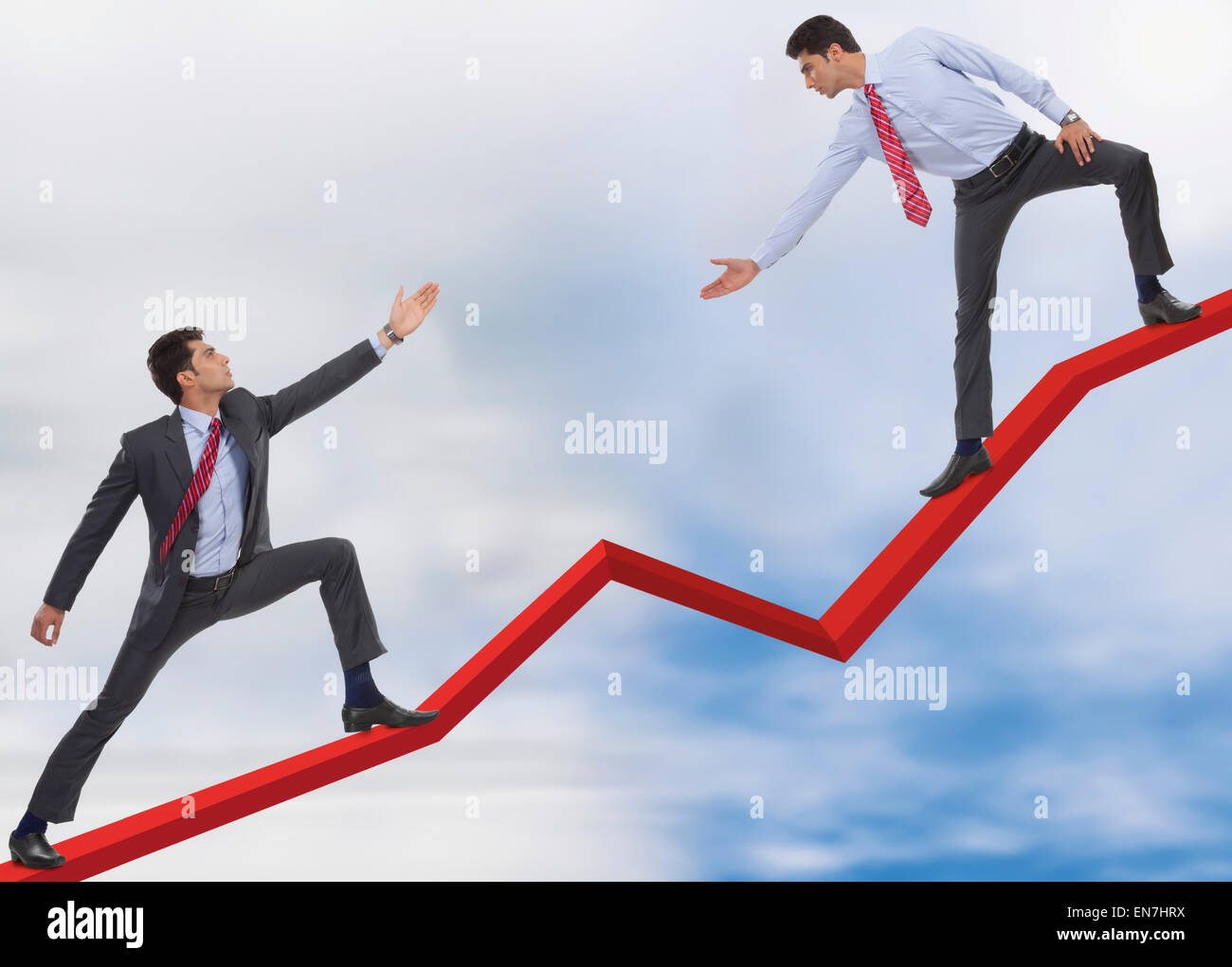 Businessman trying help fellow businessman Stock Photo - Alamy