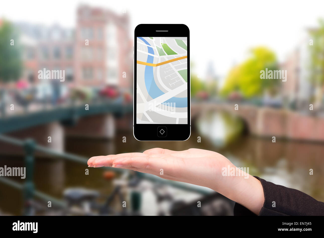 Composite image of hand showing map app on phone Stock Photo - Alamy