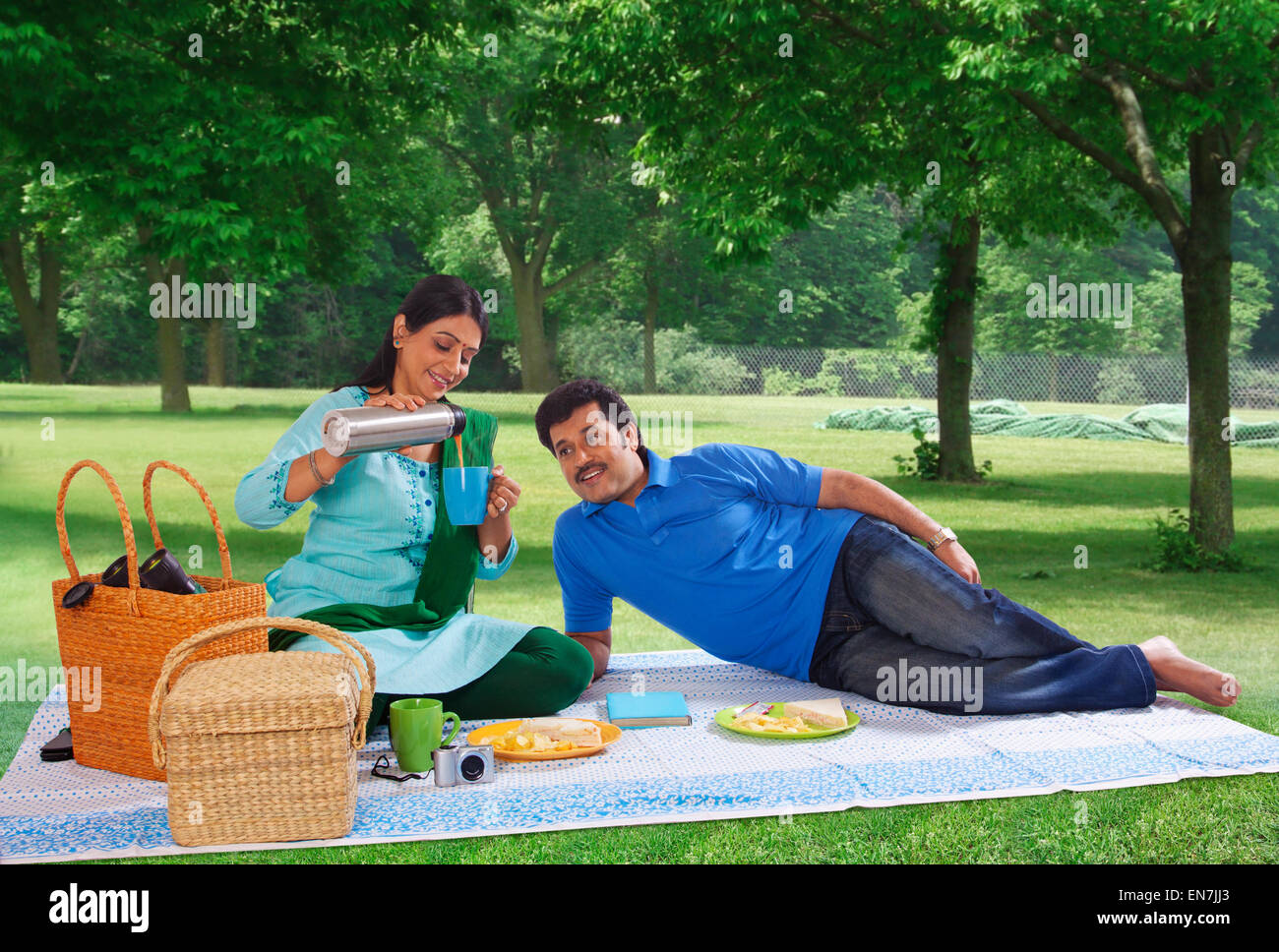 Couple having a picnic Stock Photo - Alamy