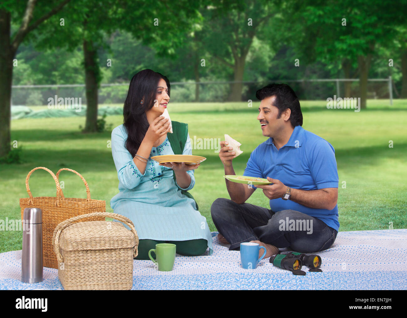 Couple having a picnic Stock Photo - Alamy