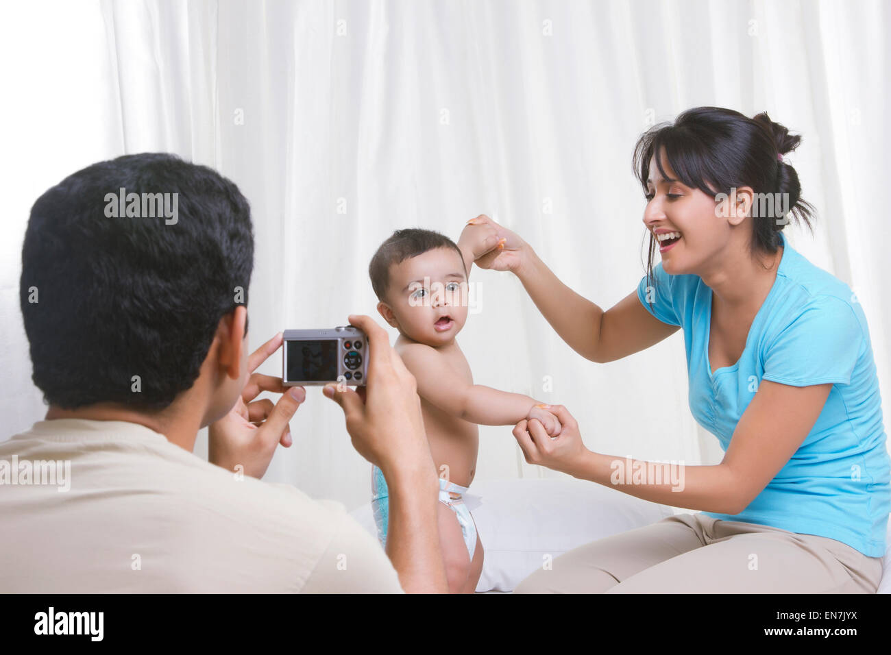 Father taking picture of mother and baby Stock Photo - Alamy