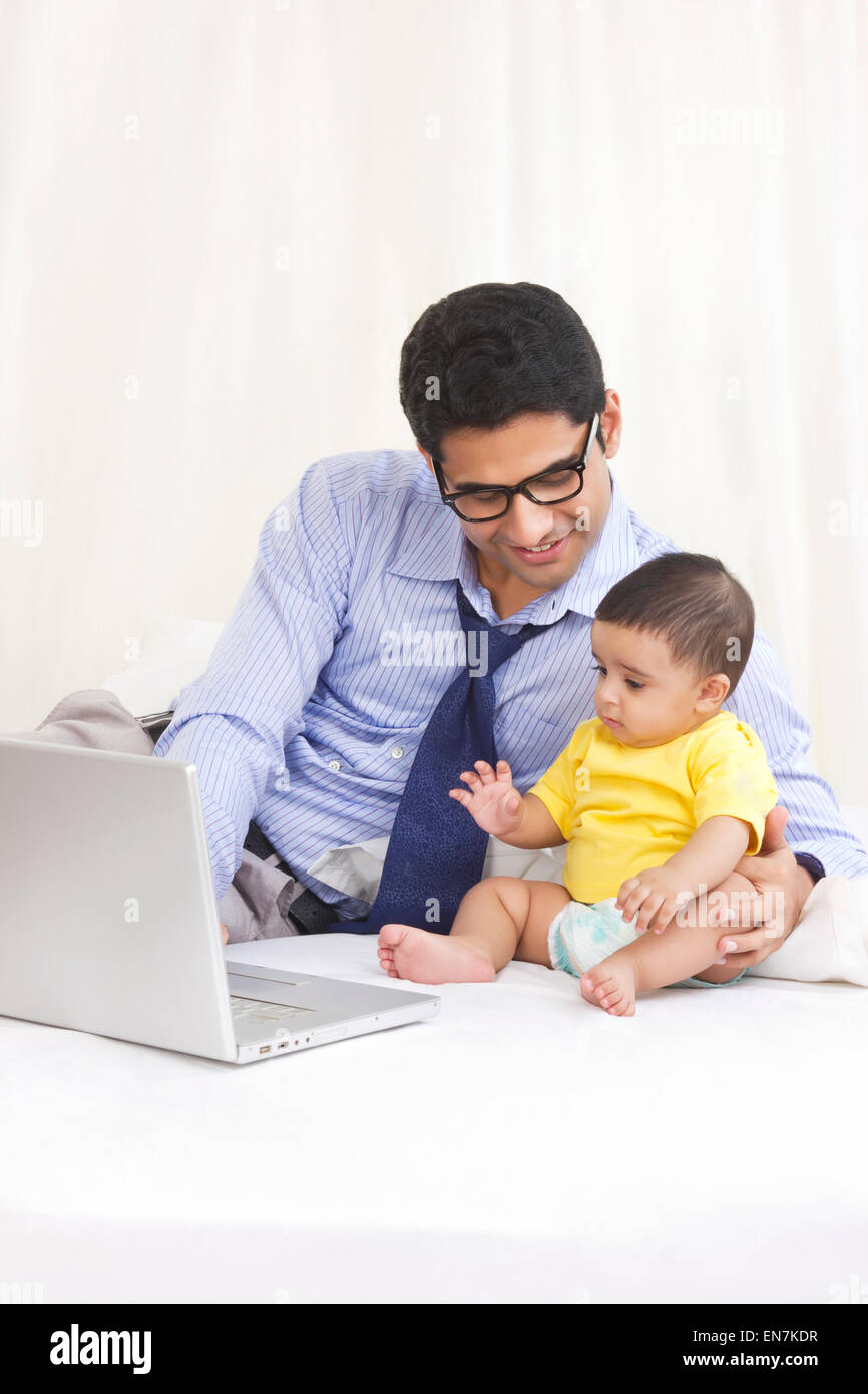 Father and baby with laptop Stock Photo - Alamy