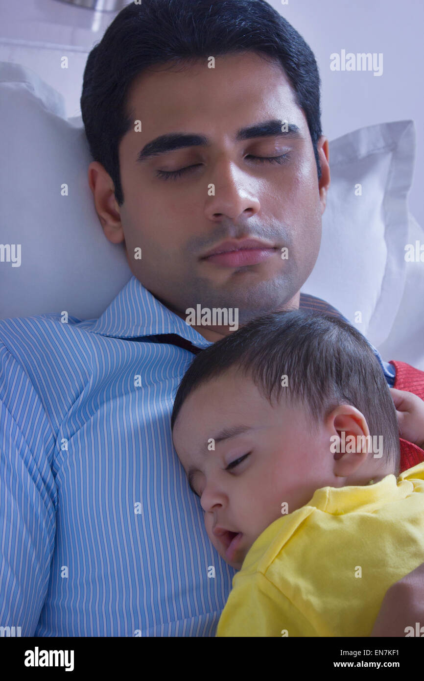 Close-up of father and baby sleeping Stock Photo - Alamy