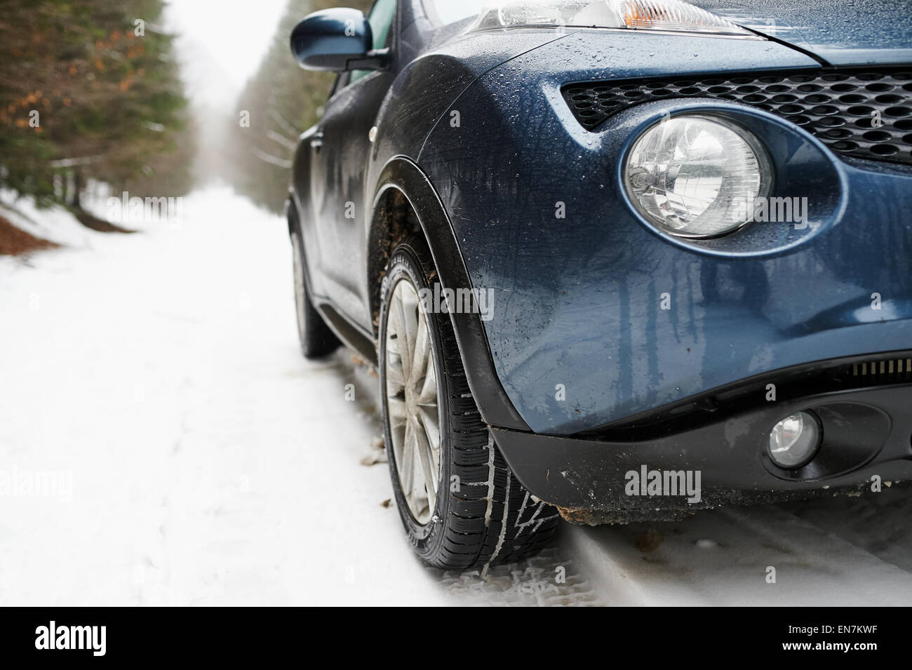 Closeup of a car on the road covered with snow Stock Photo - Alamy