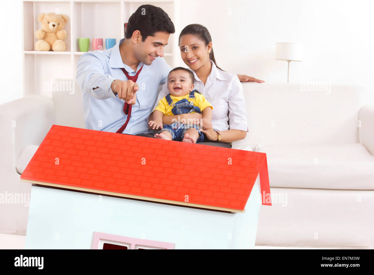 Portrait of family with model house Stock Photo - Alamy