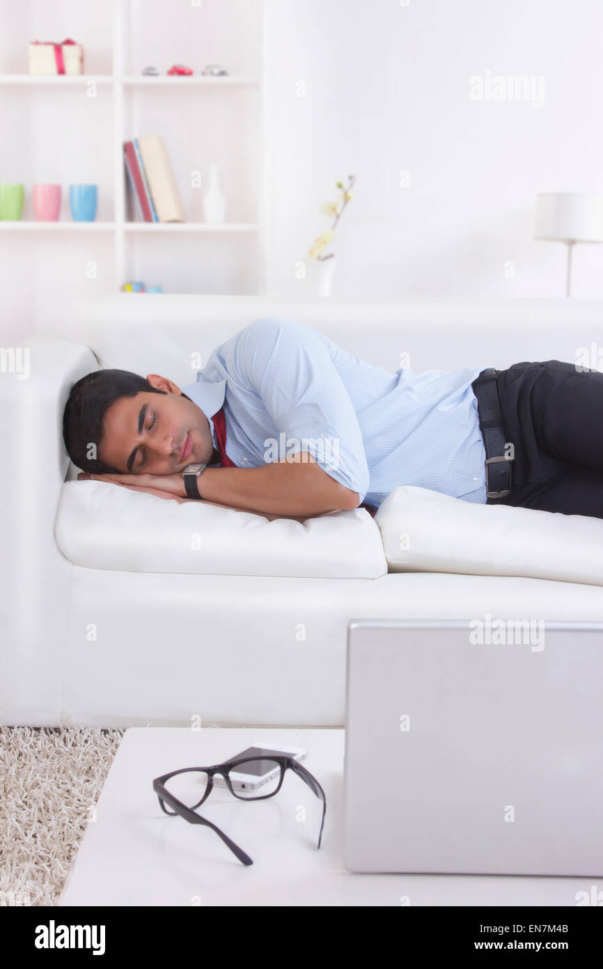 Man sleeping on sofa Stock Photo - Alamy