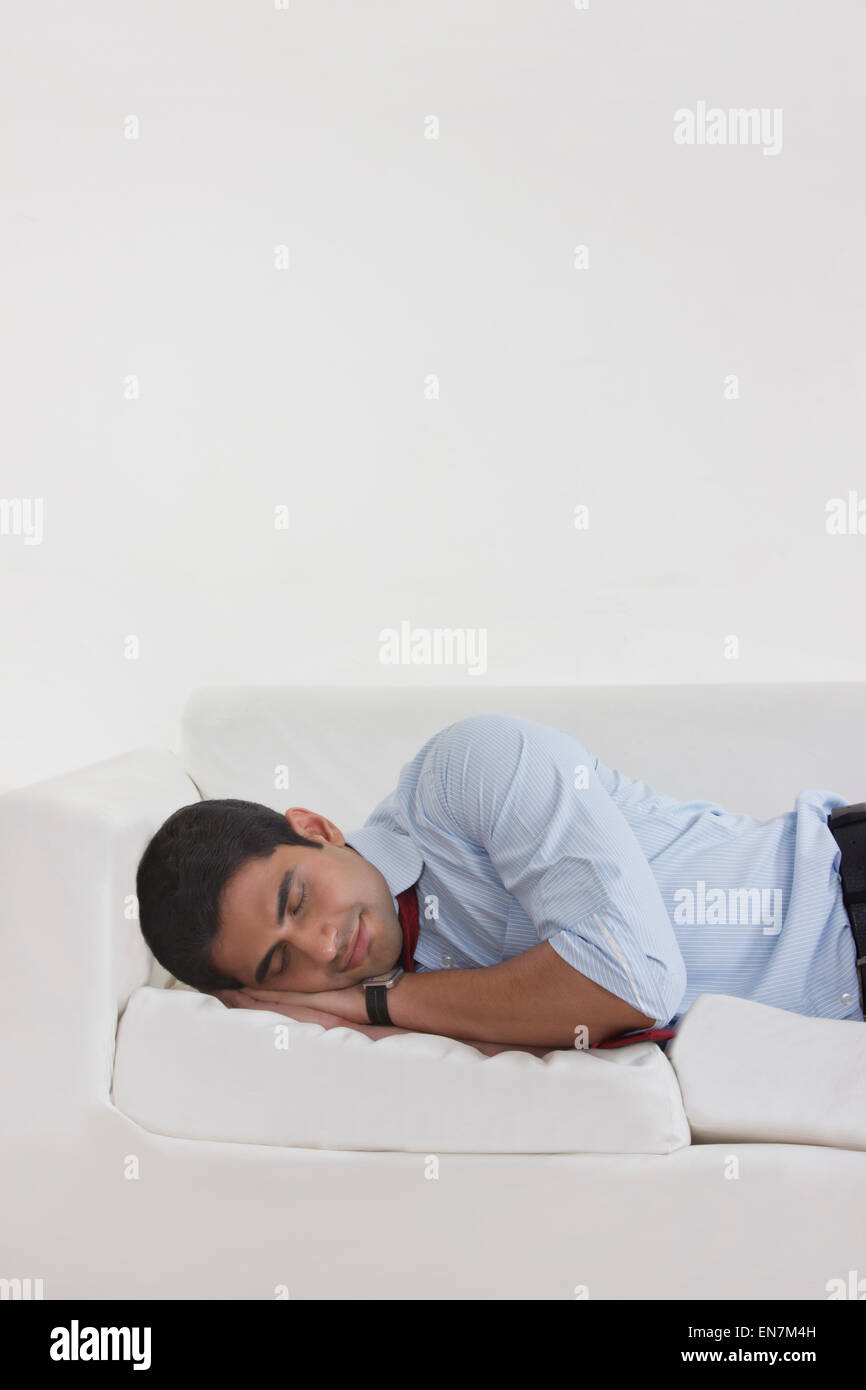 Man sleeping on sofa Stock Photo - Alamy