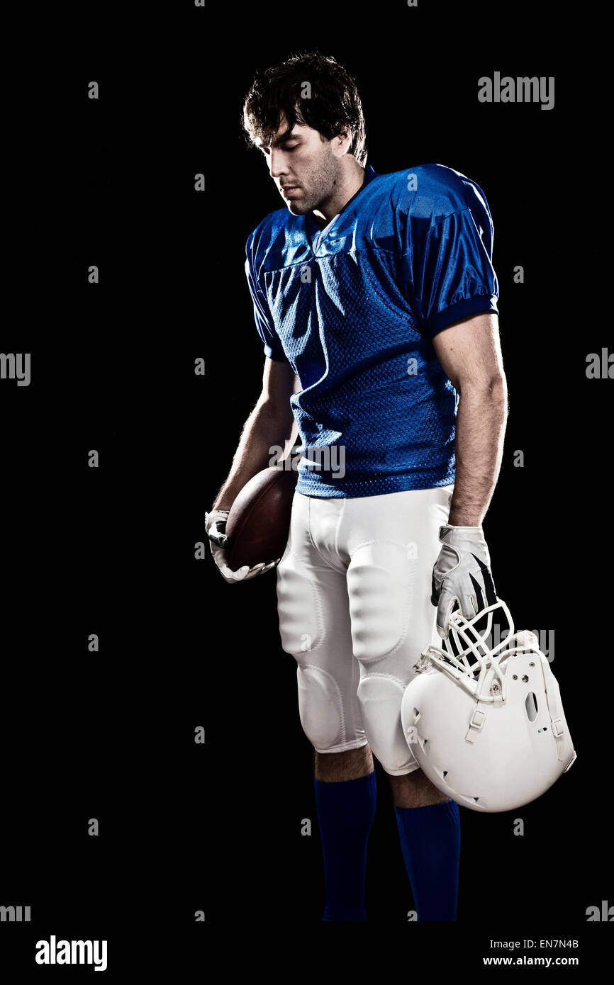 Football Player with number on a blue uniform and a ball in the hand ...