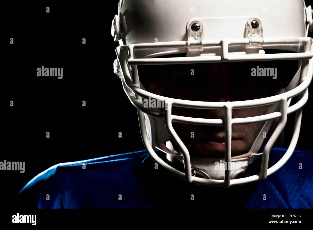 Football Player with number on a blue uniform and a ball in the hand ...