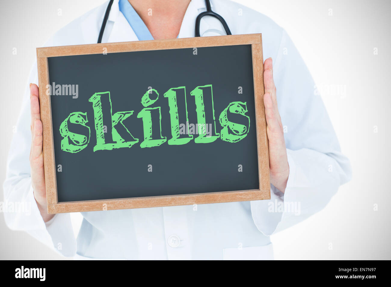 Skills against doctor showing chalkboard Stock Photo - Alamy