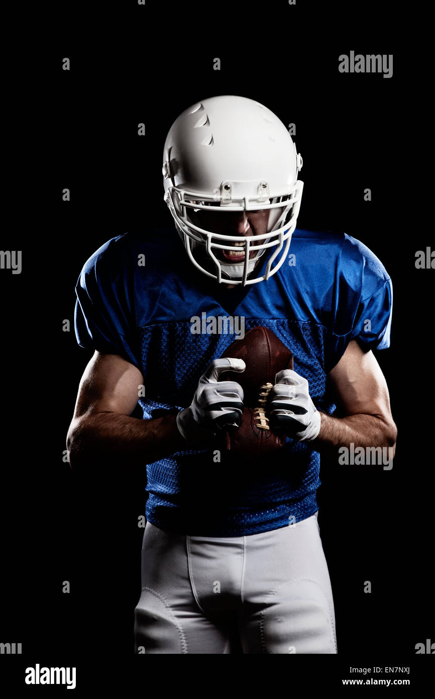 Football Player with number on a blue uniform and a ball in the hand ...