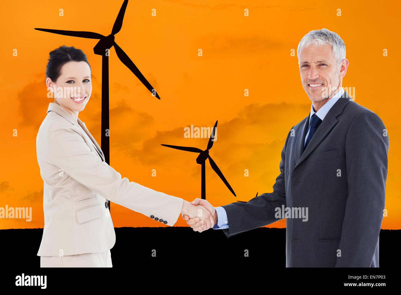 Composite image of smiling business people shaking hands while looking ...