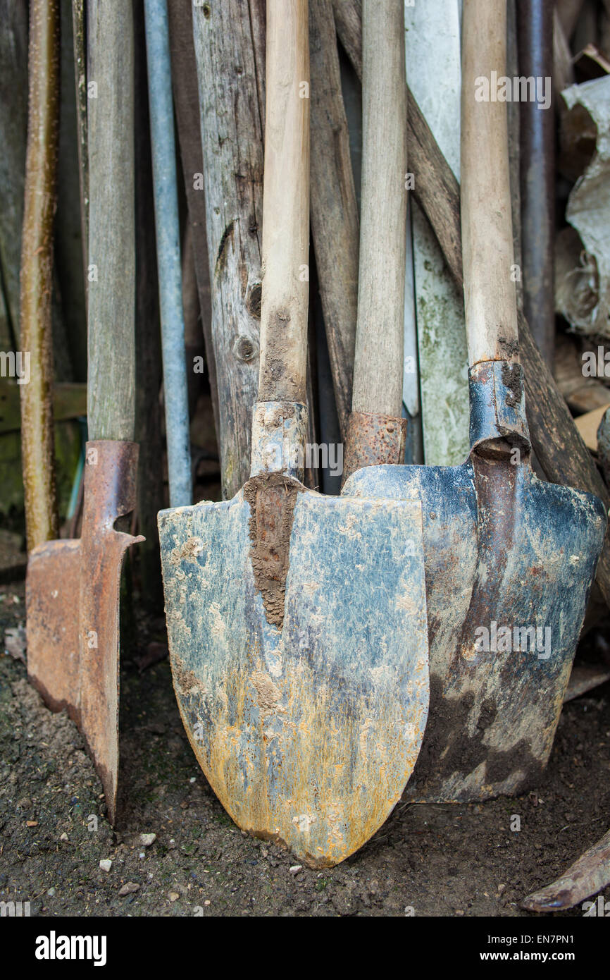 Used and worn gardening tools in a shed, waiting spring farm work Stock ...