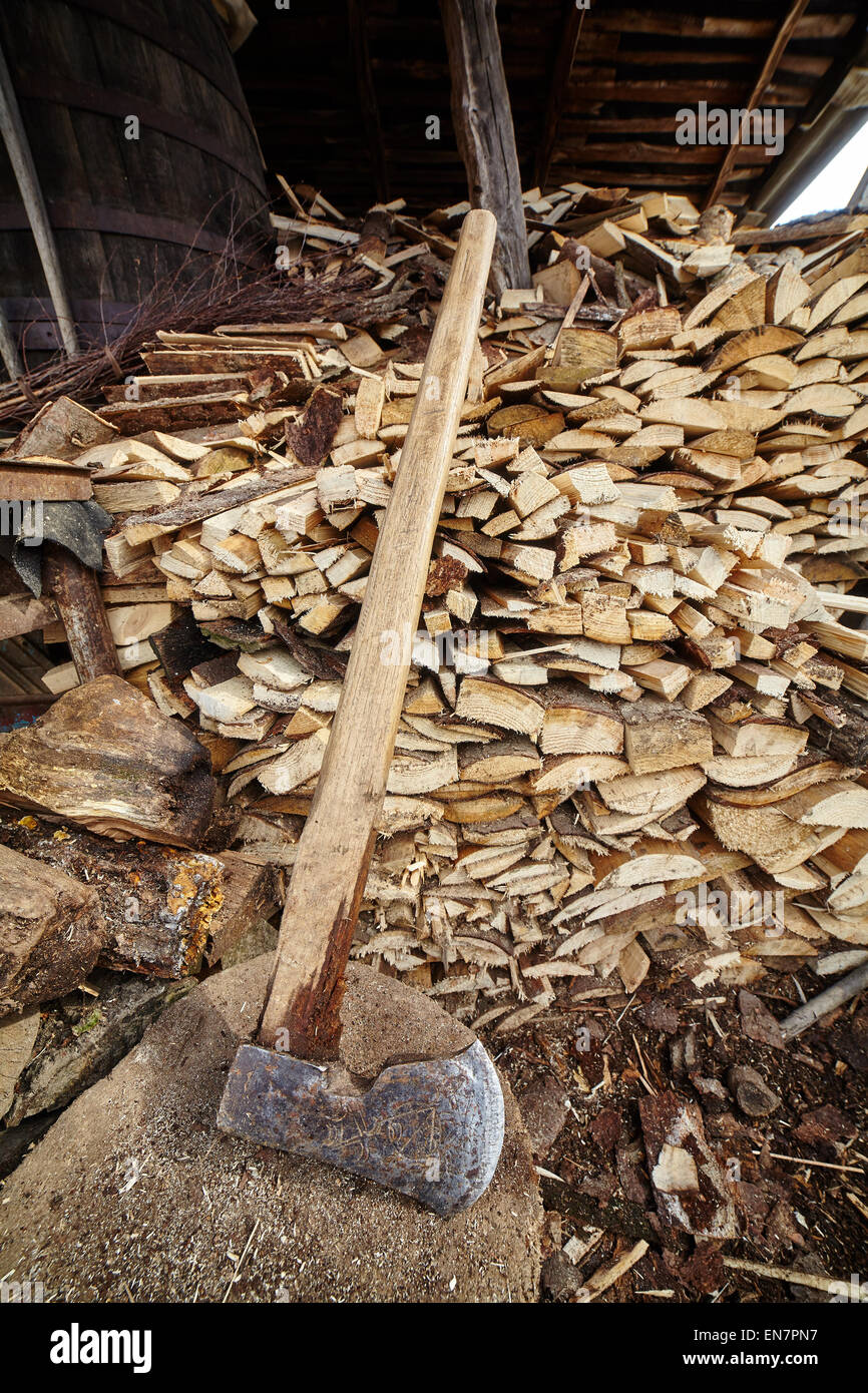 Big old ax near a stack of firewood in a shed Stock Photo - Alamy