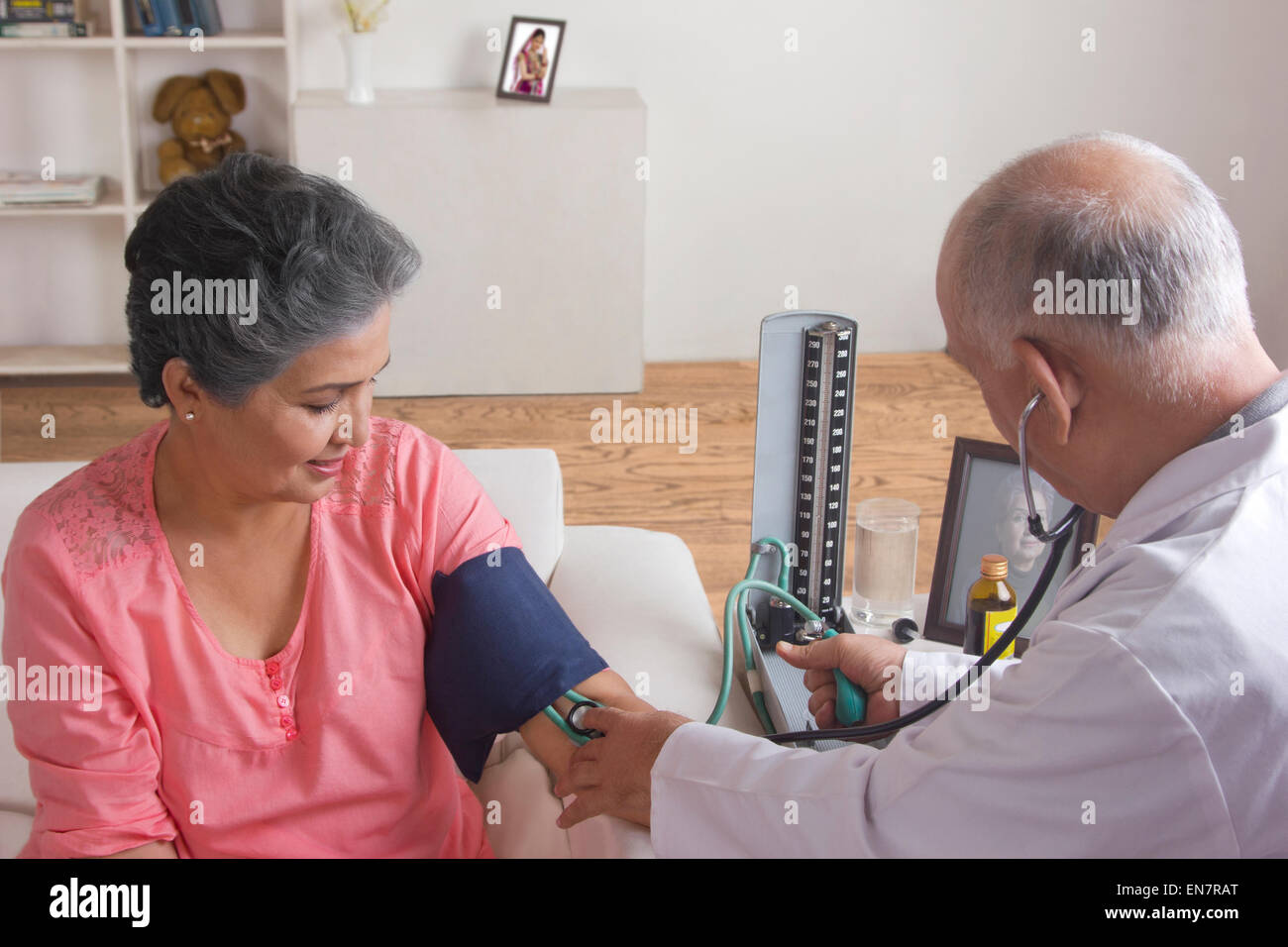 Old woman getting her blood pressure checked Stock Photo - Alamy