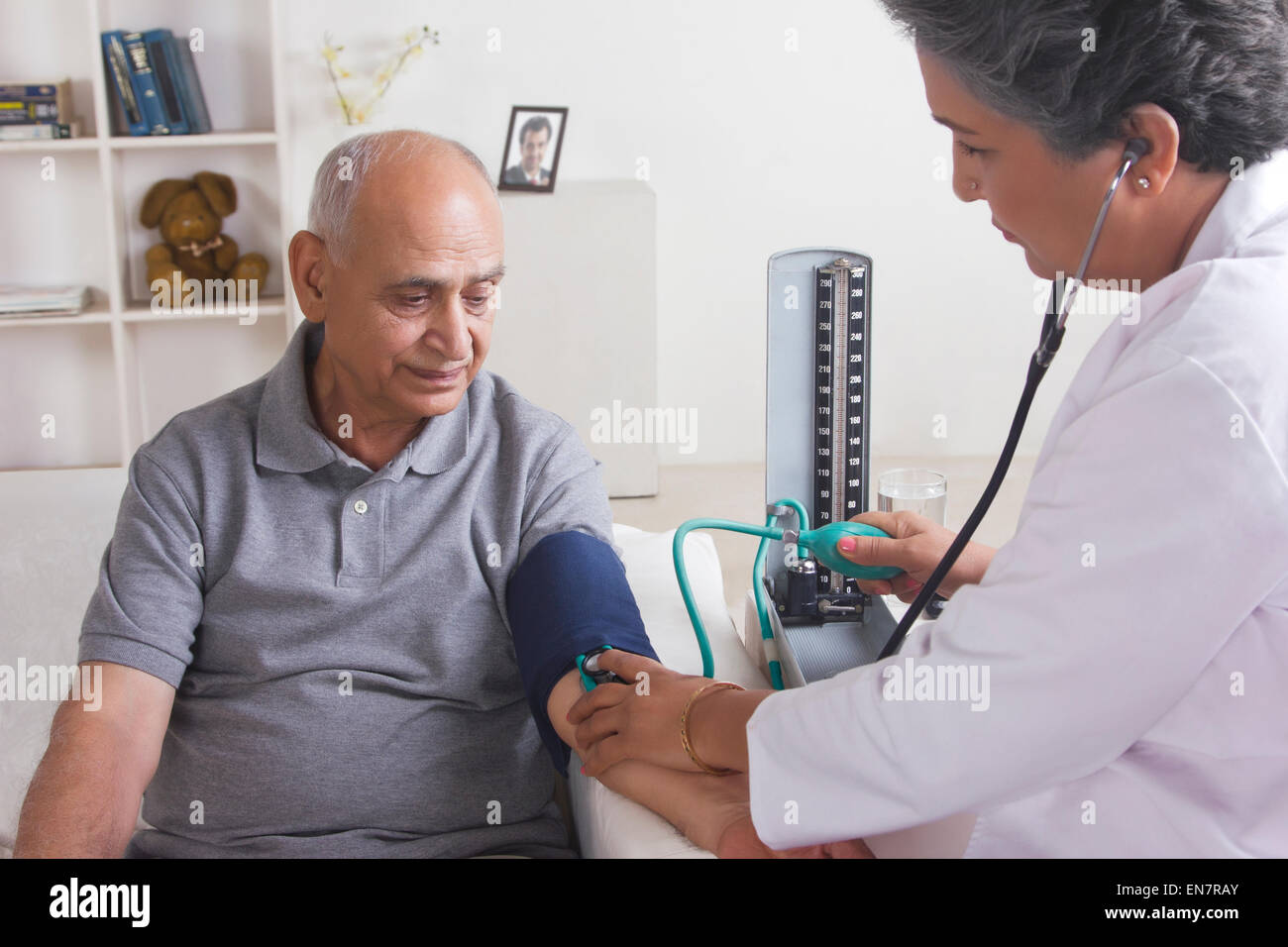 Old man getting his blood pressure checked Stock Photo - Alamy