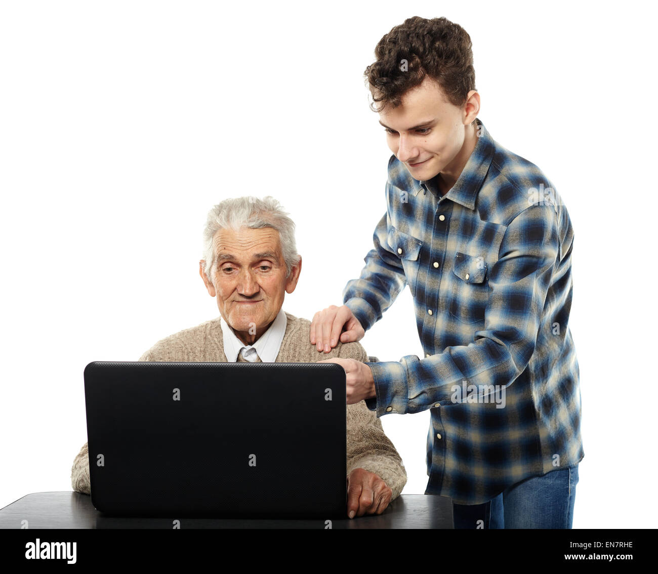 Teenage boy teaching his grandfather how to use a laptop Stock Photo ...