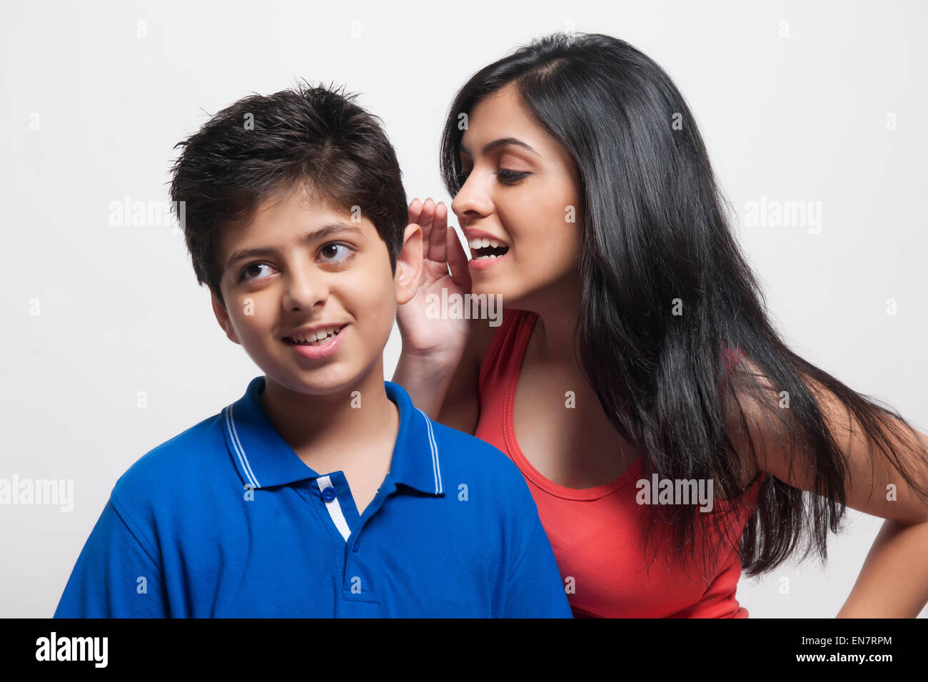 Sister whispering to her brother Stock Photo - Alamy