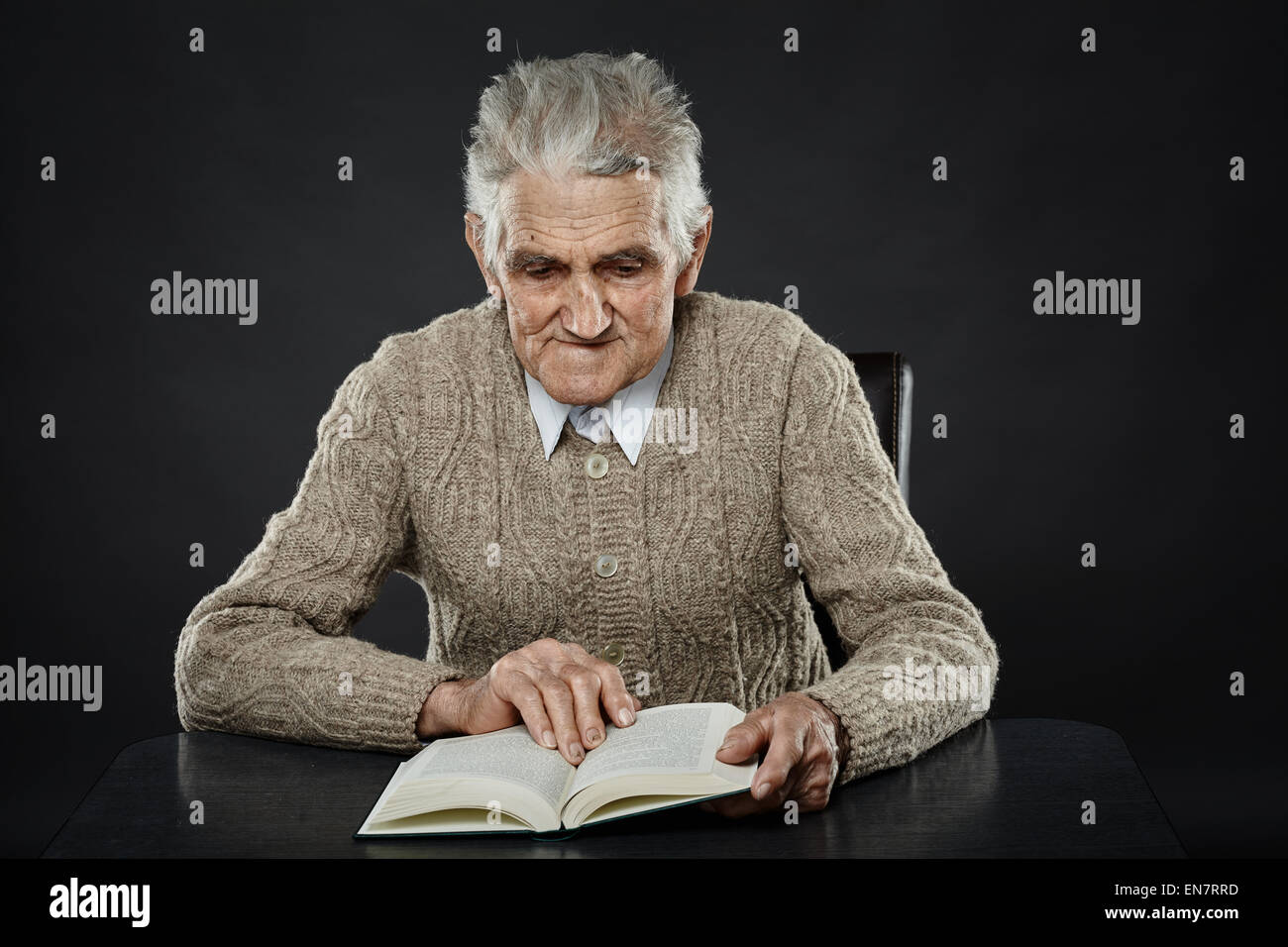 Old man reading a book, studio closeup portrait Stock Photo - Alamy