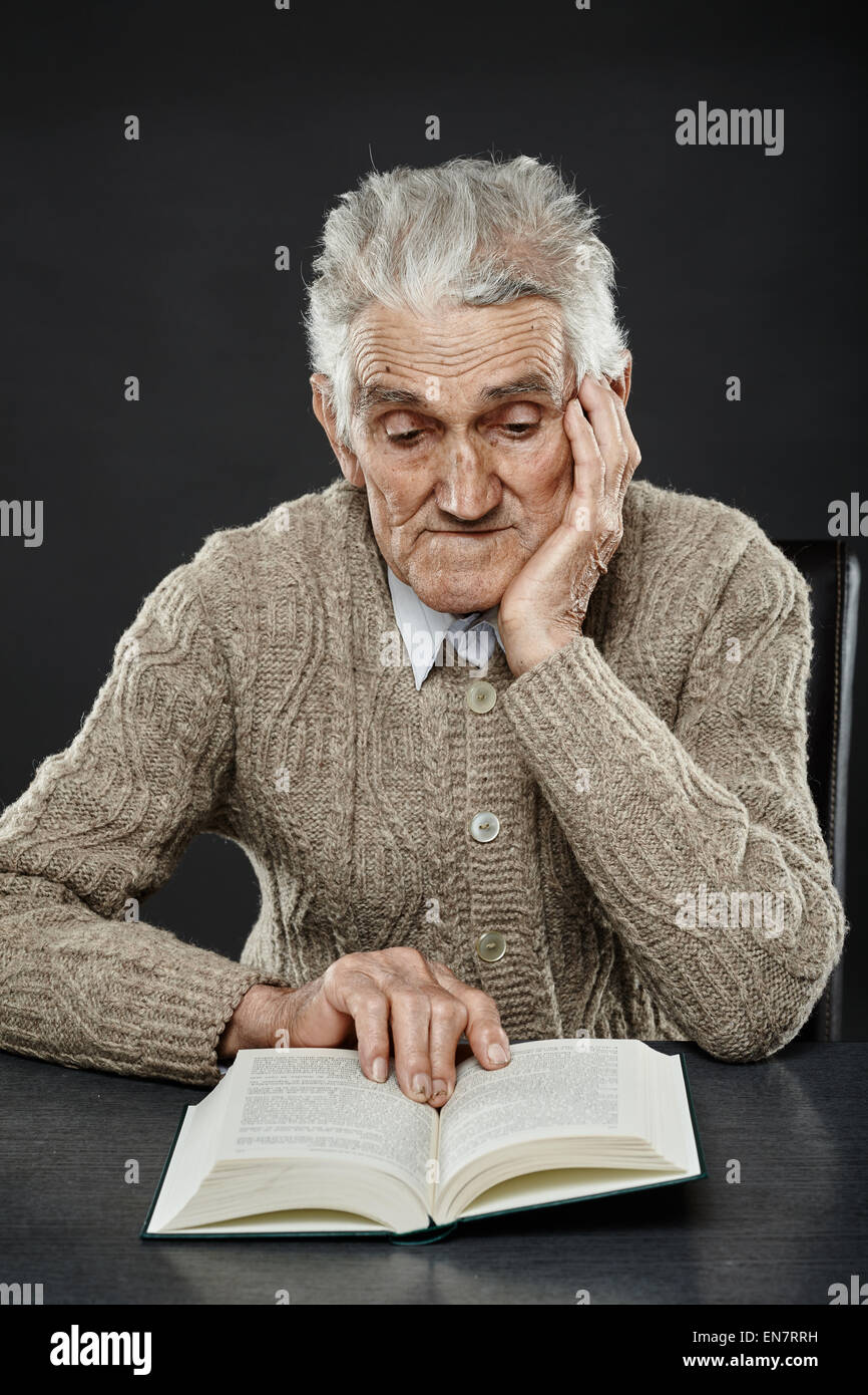 Old man reading a book, studio closeup portrait Stock Photo - Alamy