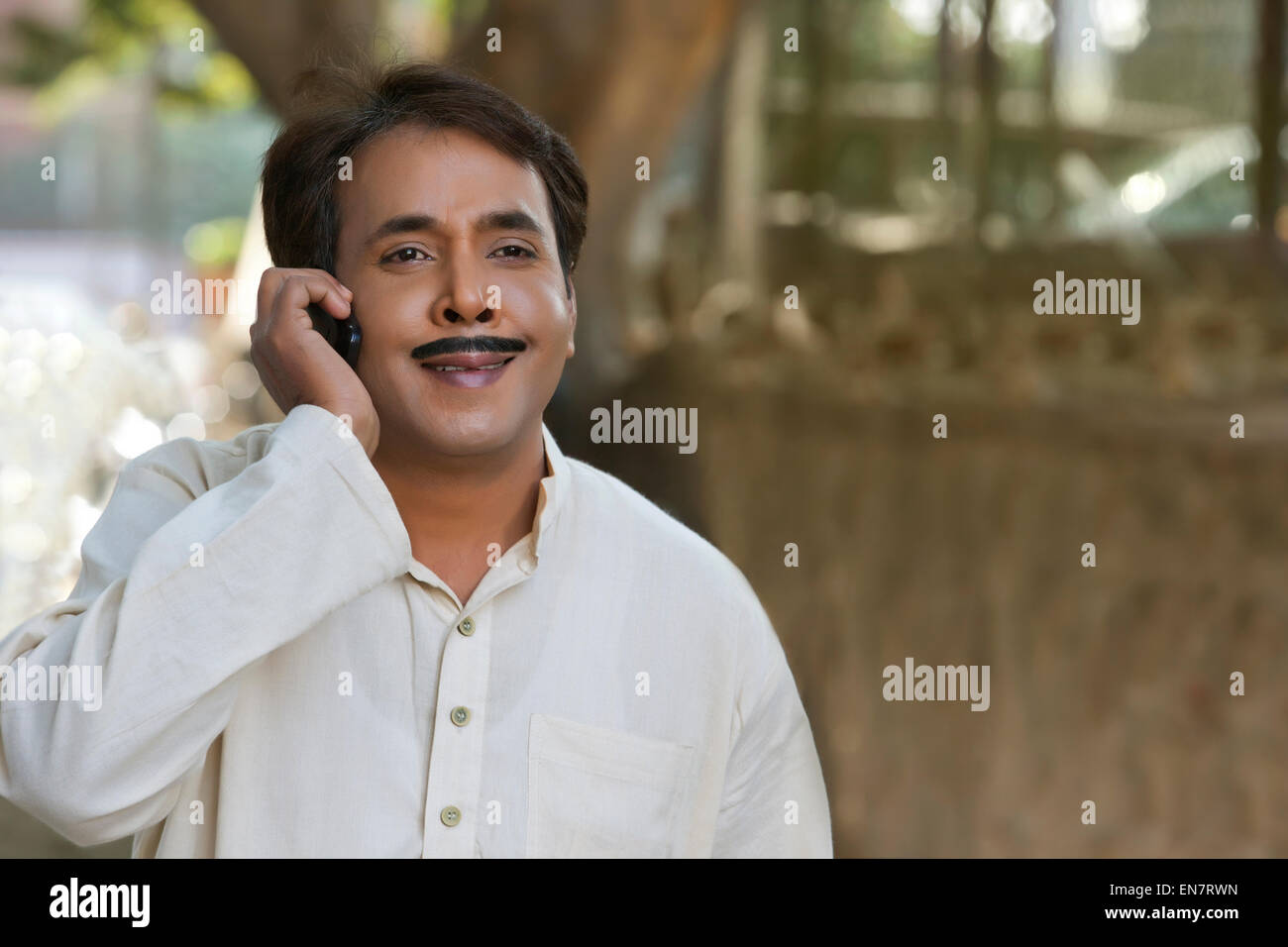 Indian man talking on phone hi-res stock photography and images - Alamy
