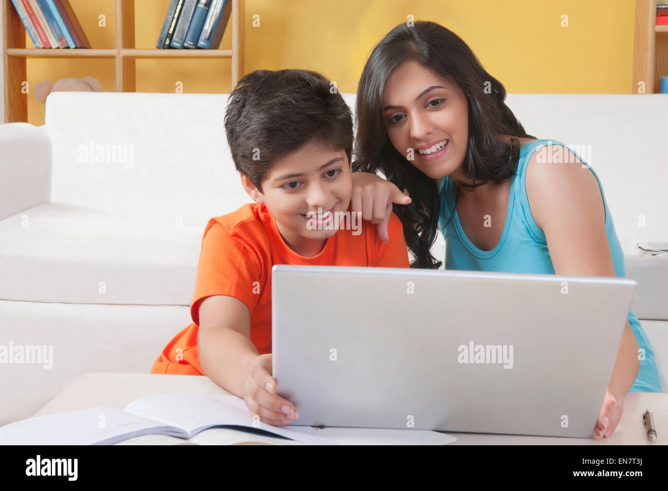 Sister and brother working on laptop Stock Photo - Alamy