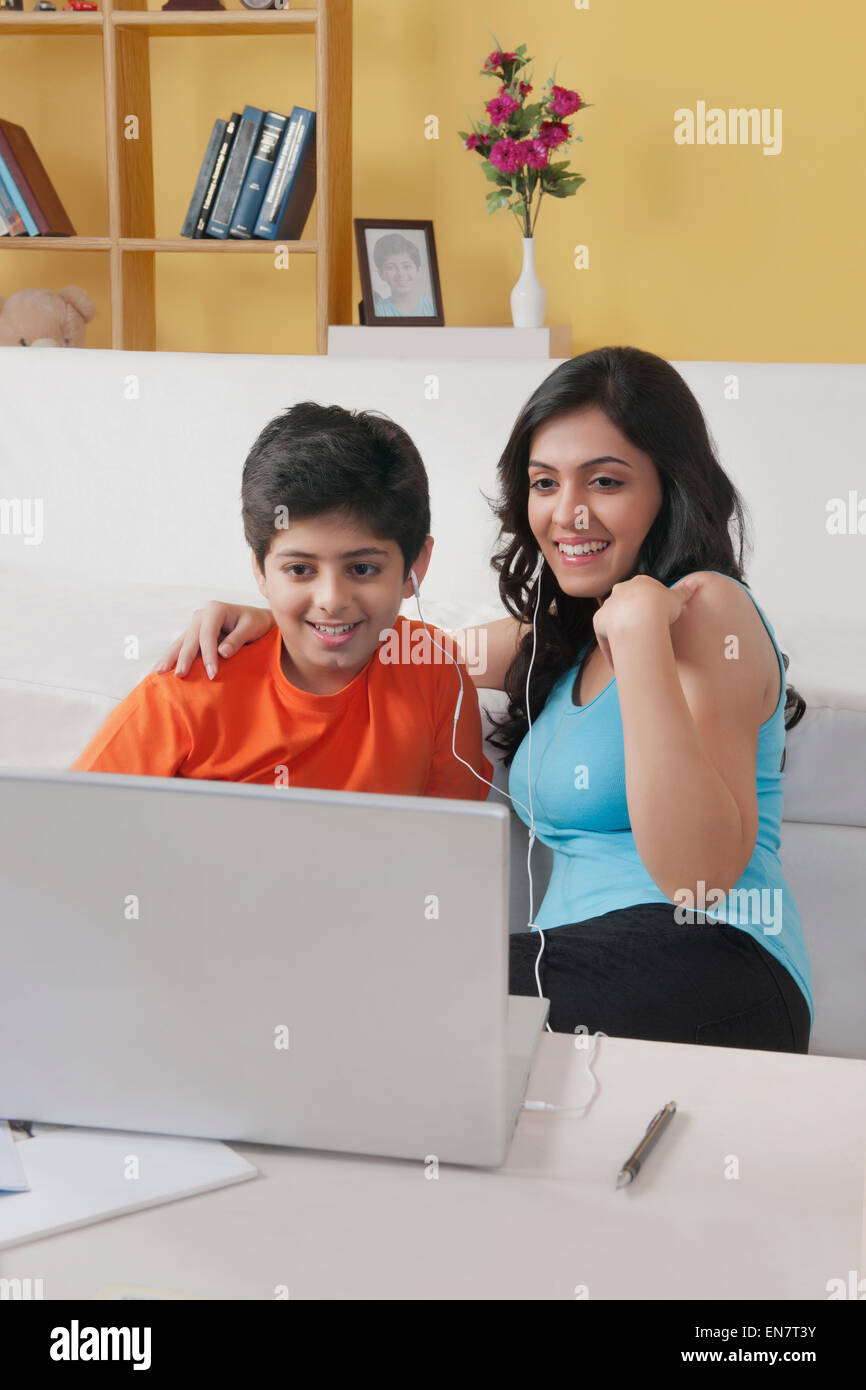 Sister and brother watching laptop Stock Photo - Alamy