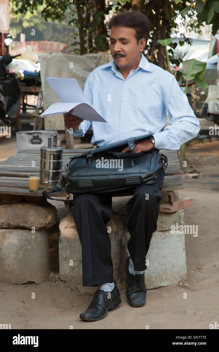 Salesman examining his paperwork Stock Photo - Alamy