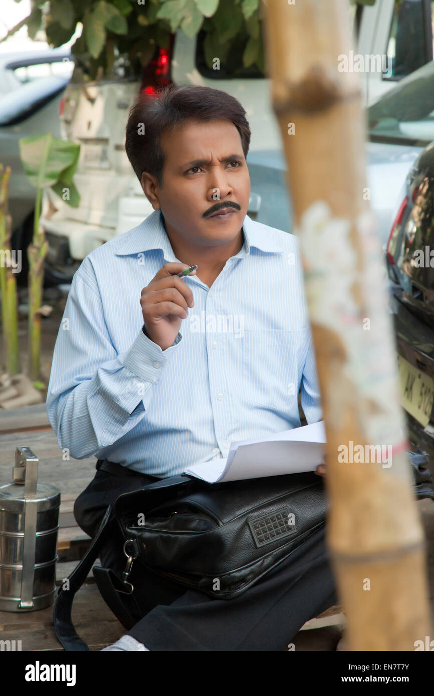 Salesman thinking pen paper work hi-res stock photography and images ...