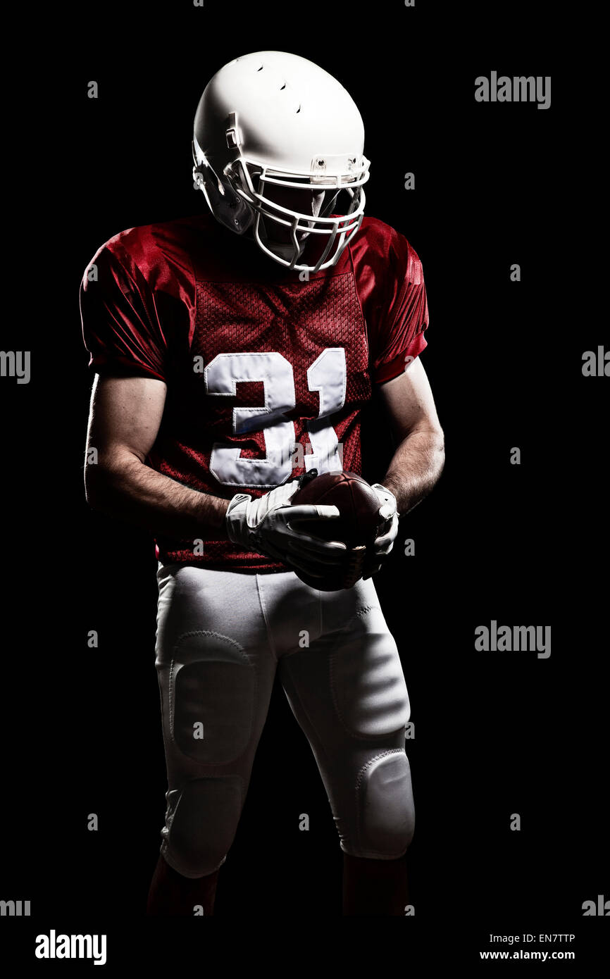 Football Player with number on a red uniform. Studio shot Stock Photo ...