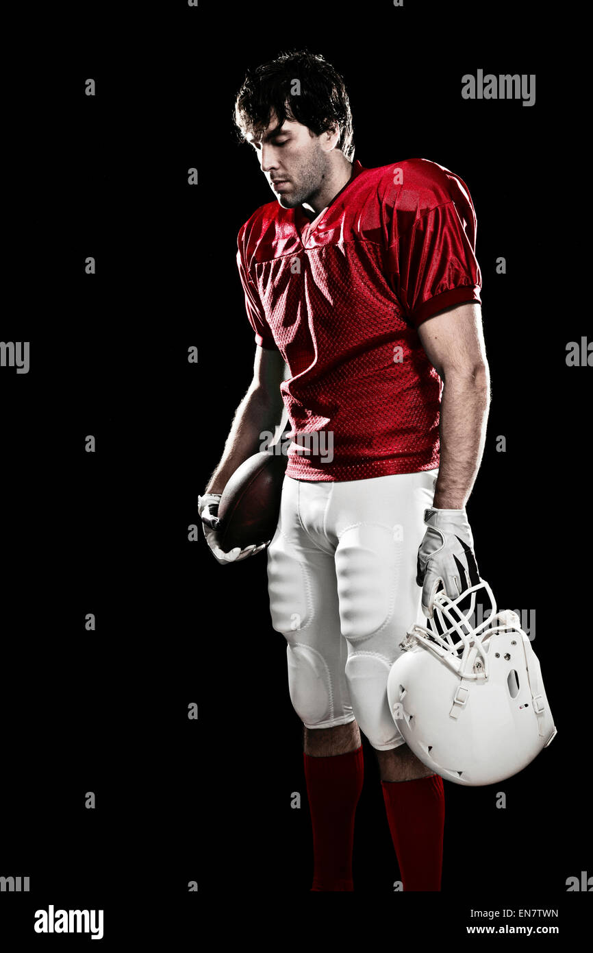 Football Player with number on a red uniform. Studio shot Stock Photo ...