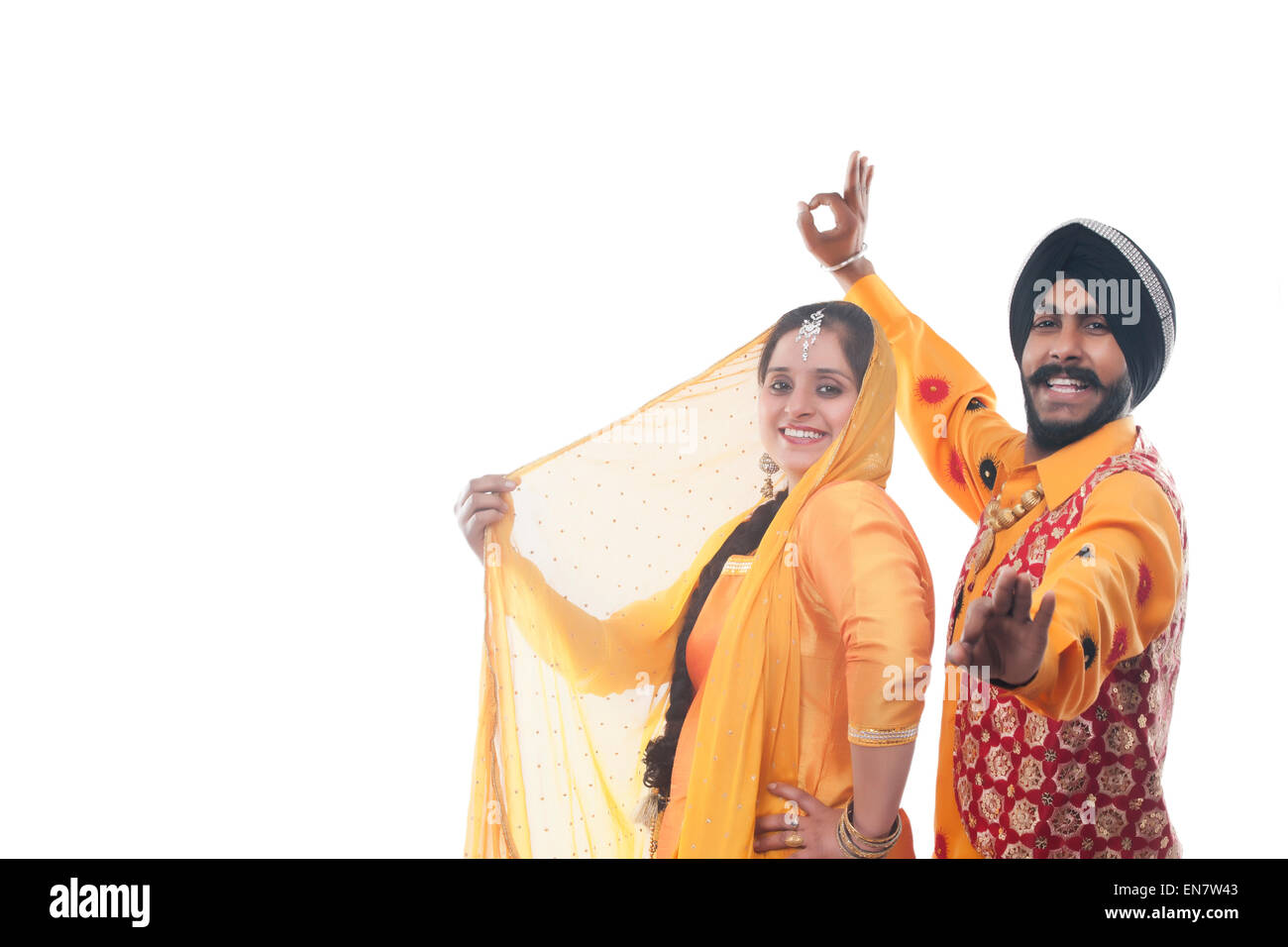 Portrait of Sikh couple doing bhangra dance Stock Photo - Alamy