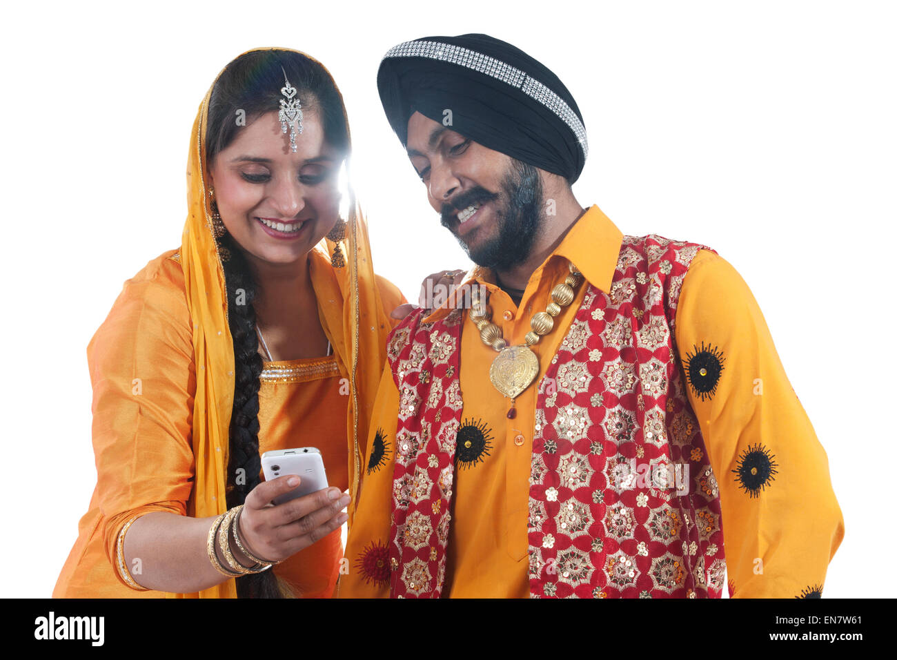Sikh couple looking at an sms Stock Photo - Alamy