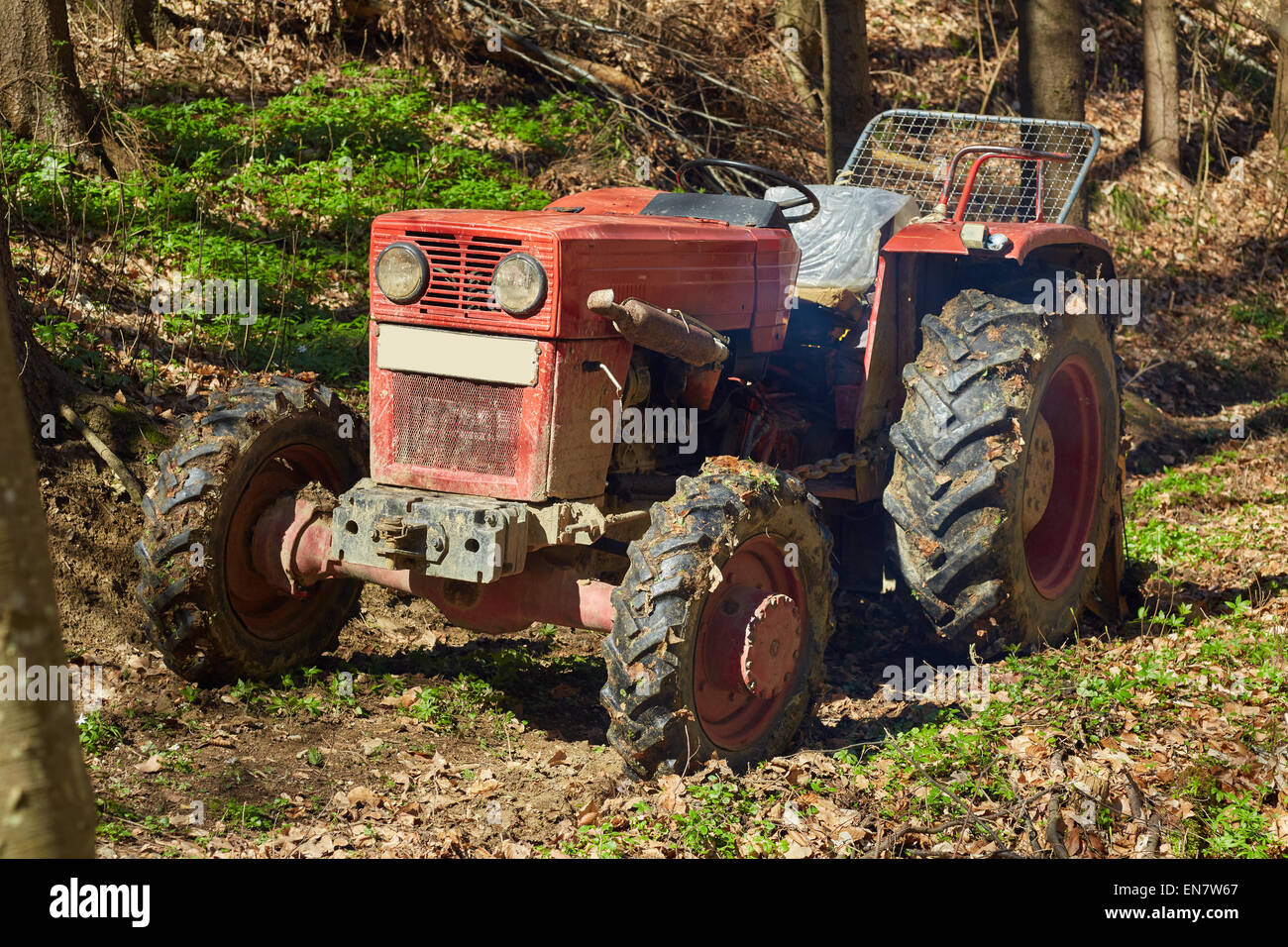 Logging tractor with an anchor winch in the forest Stock Photo - Alamy