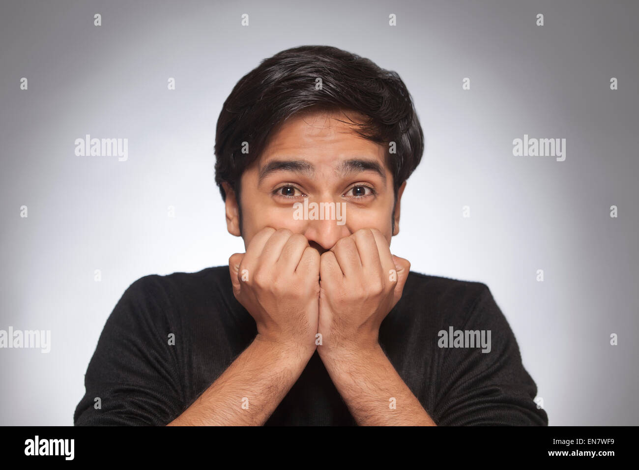 Portrait of a young man looking surprised Stock Photo - Alamy