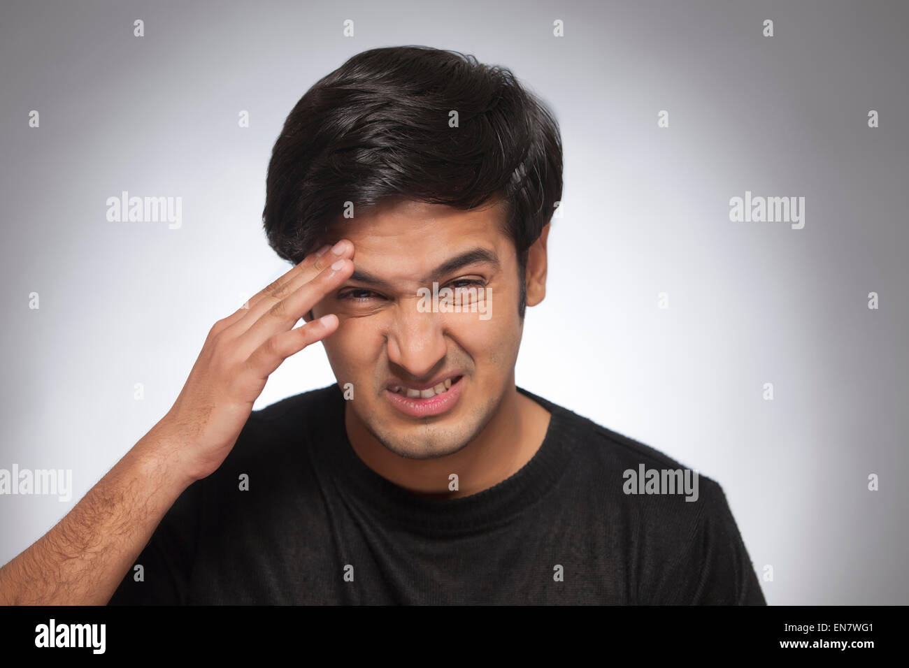 Young man with a headache Stock Photo - Alamy
