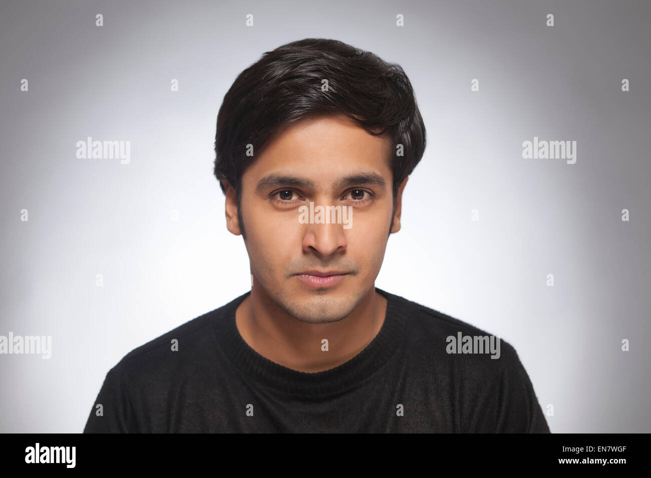 Portrait of a young man looking at camera Stock Photo - Alamy