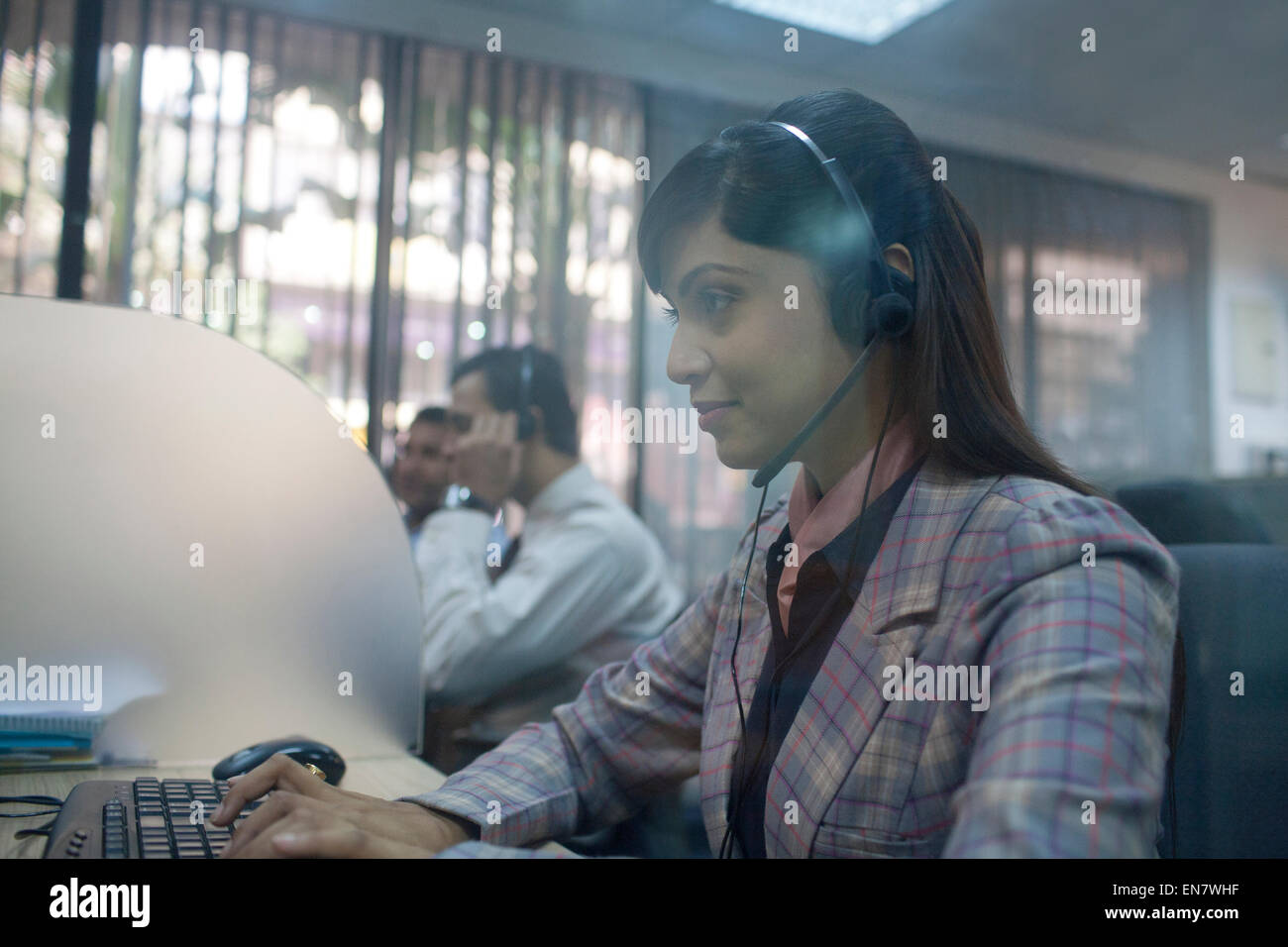 Side profile of female executive working Stock Photo - Alamy