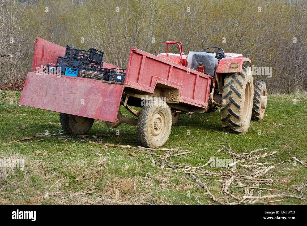 Old dirty tractor with trailer on a field Stock Photo - Alamy