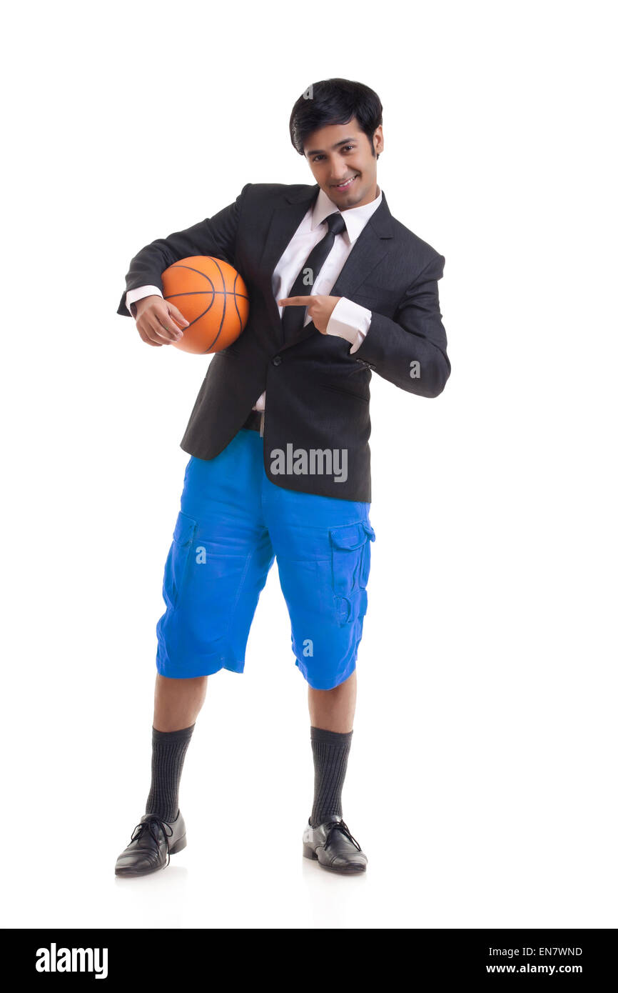 Portrait of young man pointing at basketball Stock Photo - Alamy