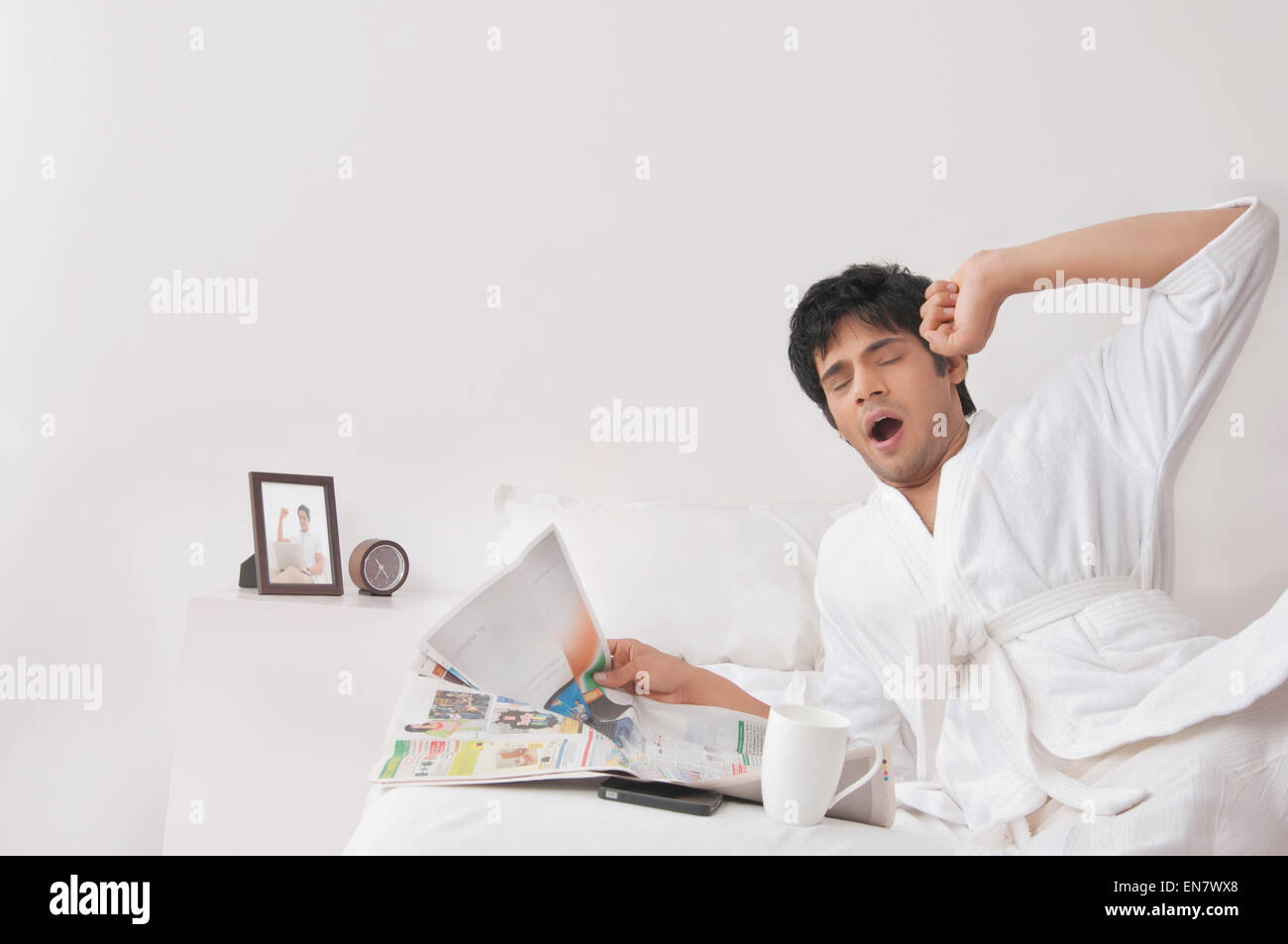 Young man yawning Stock Photo - Alamy