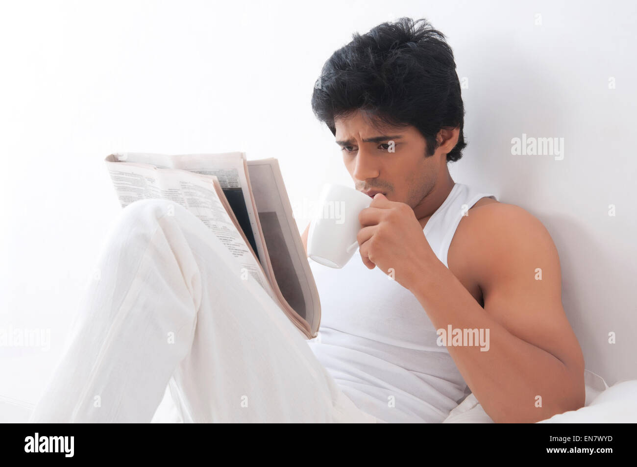 Young man reading newspaper Stock Photo - Alamy Young man reading newspaper Stock Photo - Alamy