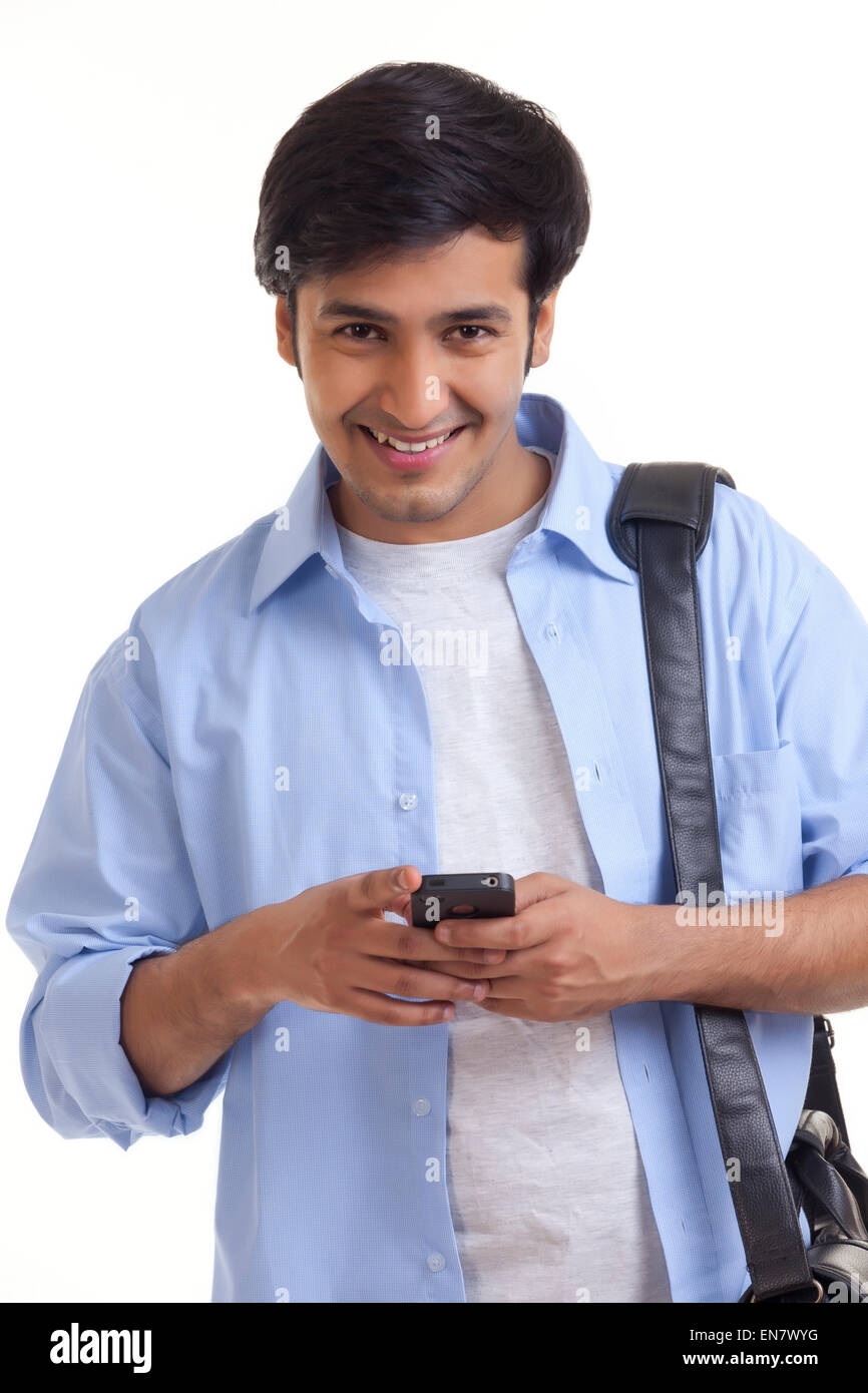 Portrait of smiling young man using mobile phone Stock Photo - Alamy