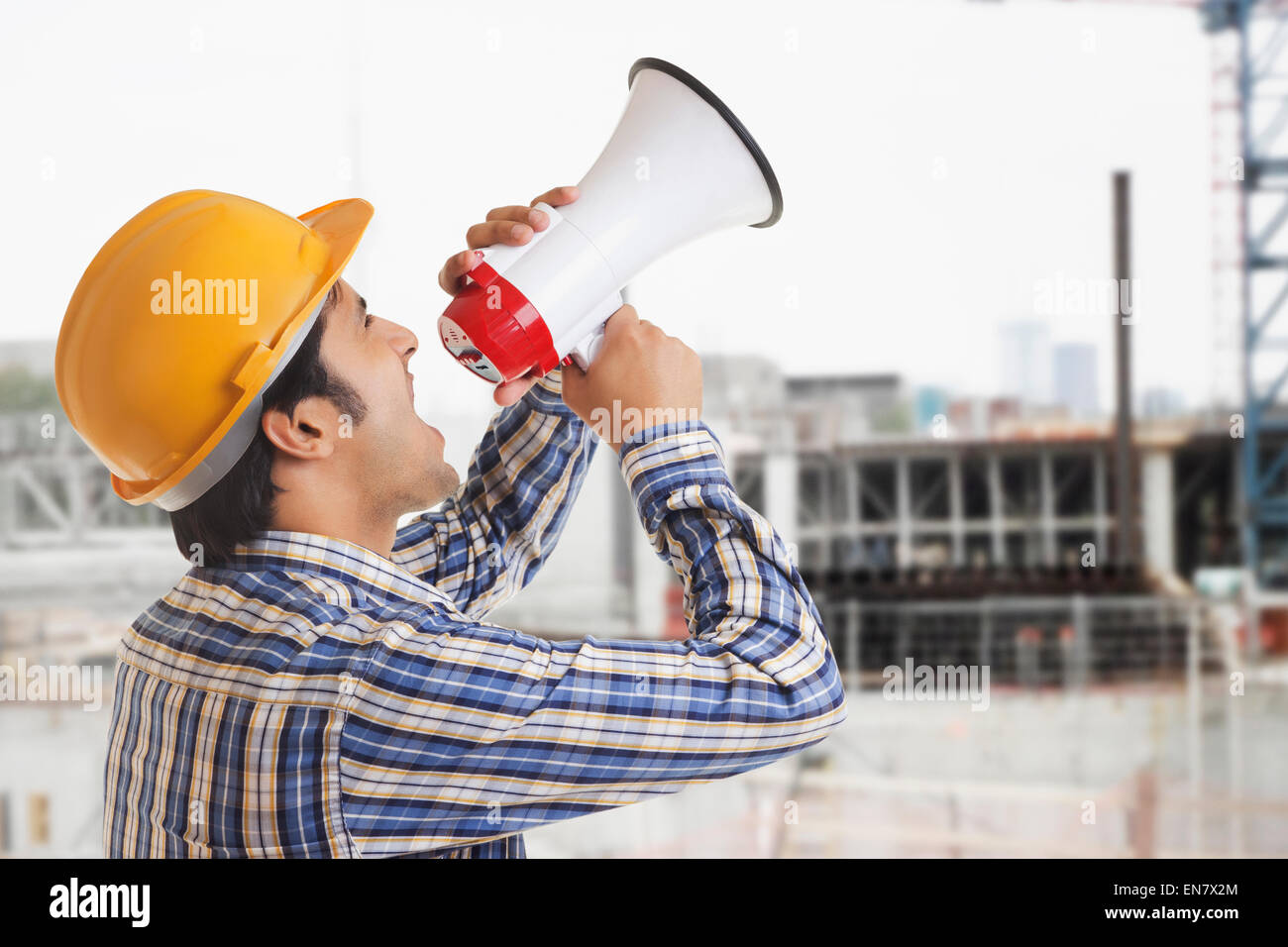 Building Contractor shouting through megaphone Stock Photo - Alamy