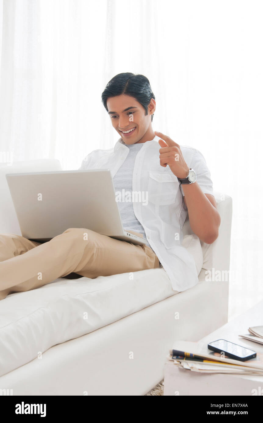 Young man with laptop smiling Stock Photo - Alamy