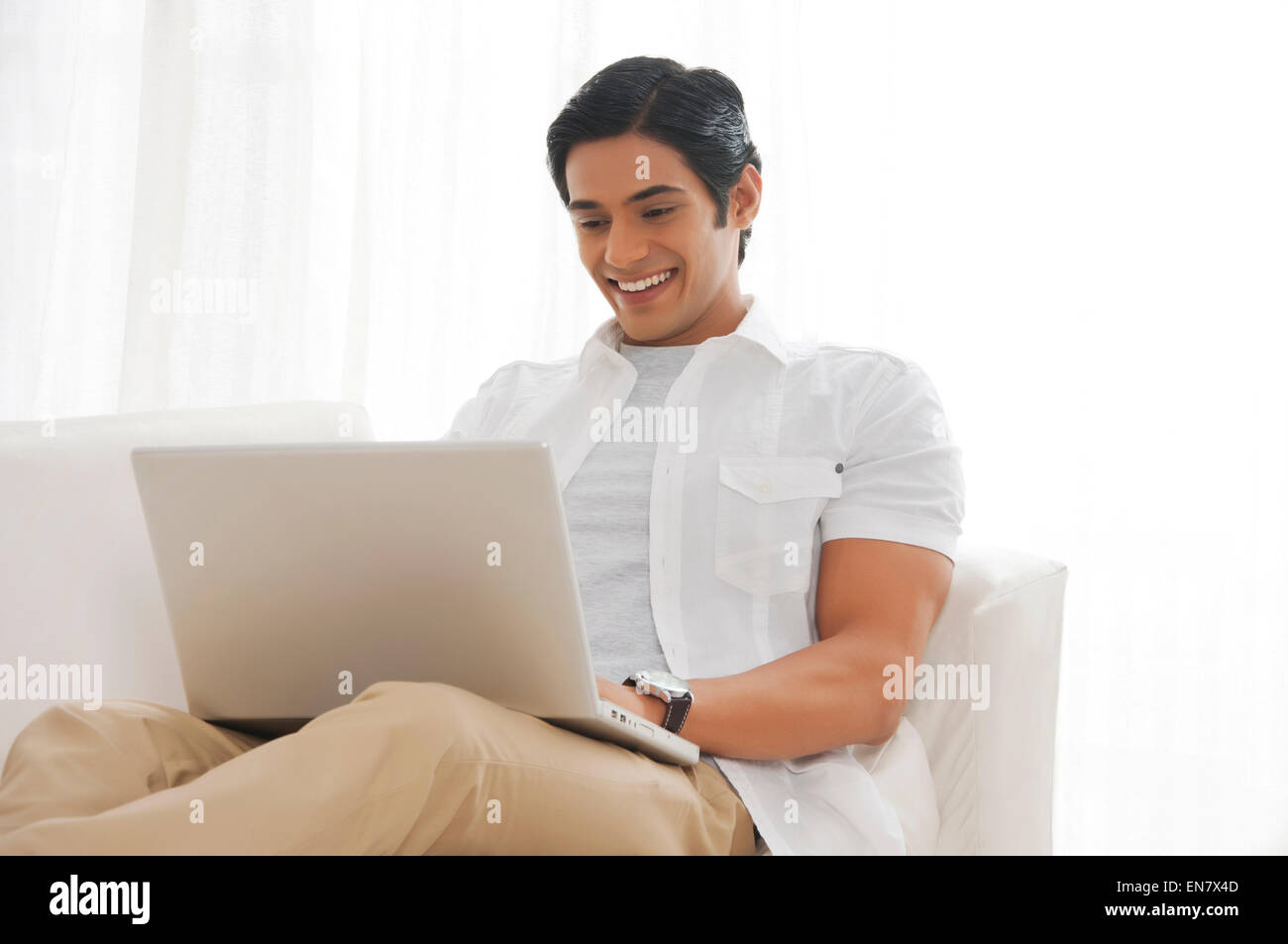 Young man with laptop smiling Stock Photo - Alamy