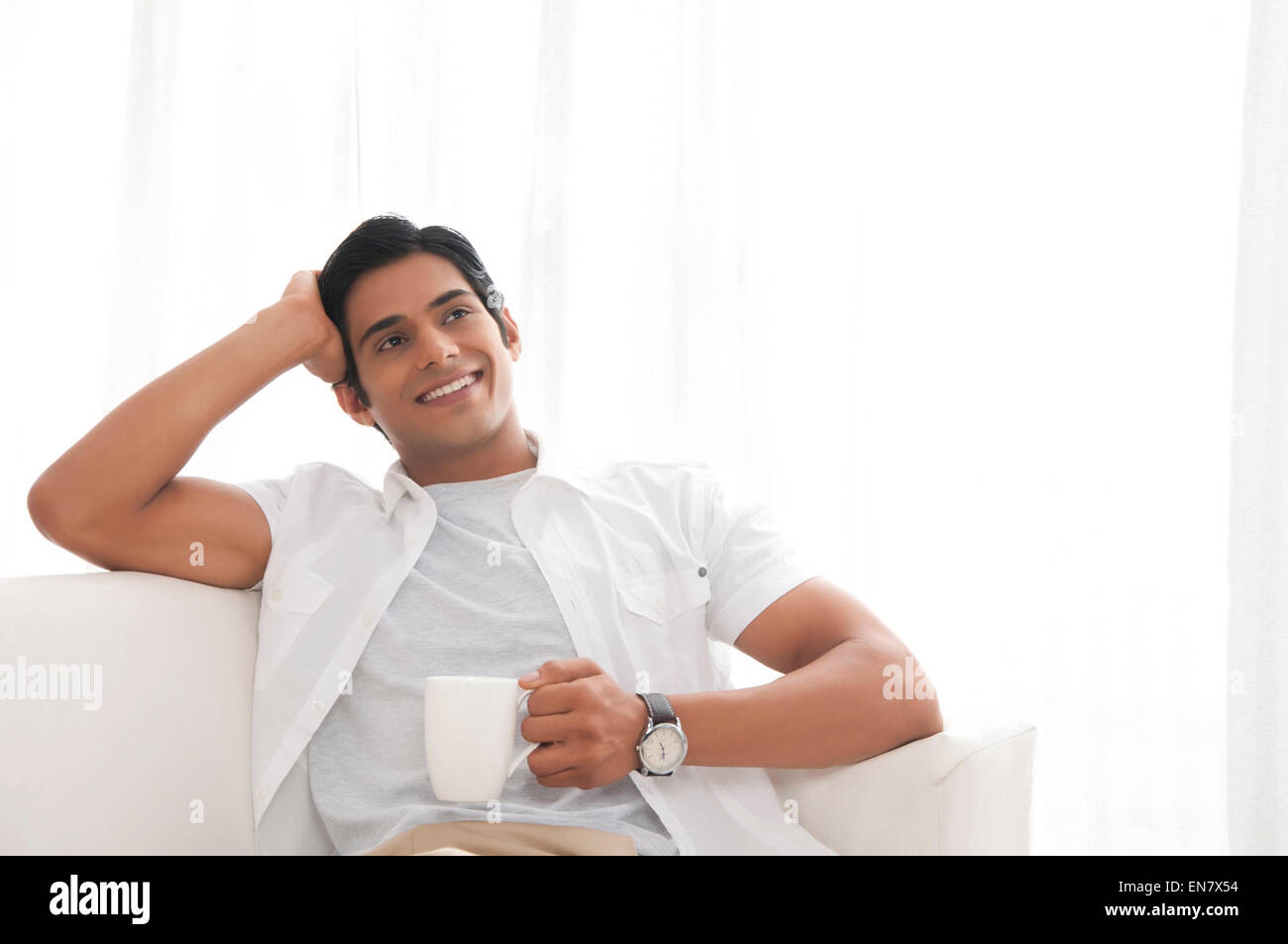 Young man mug tea thinking hi-res stock photography and images - Alamy