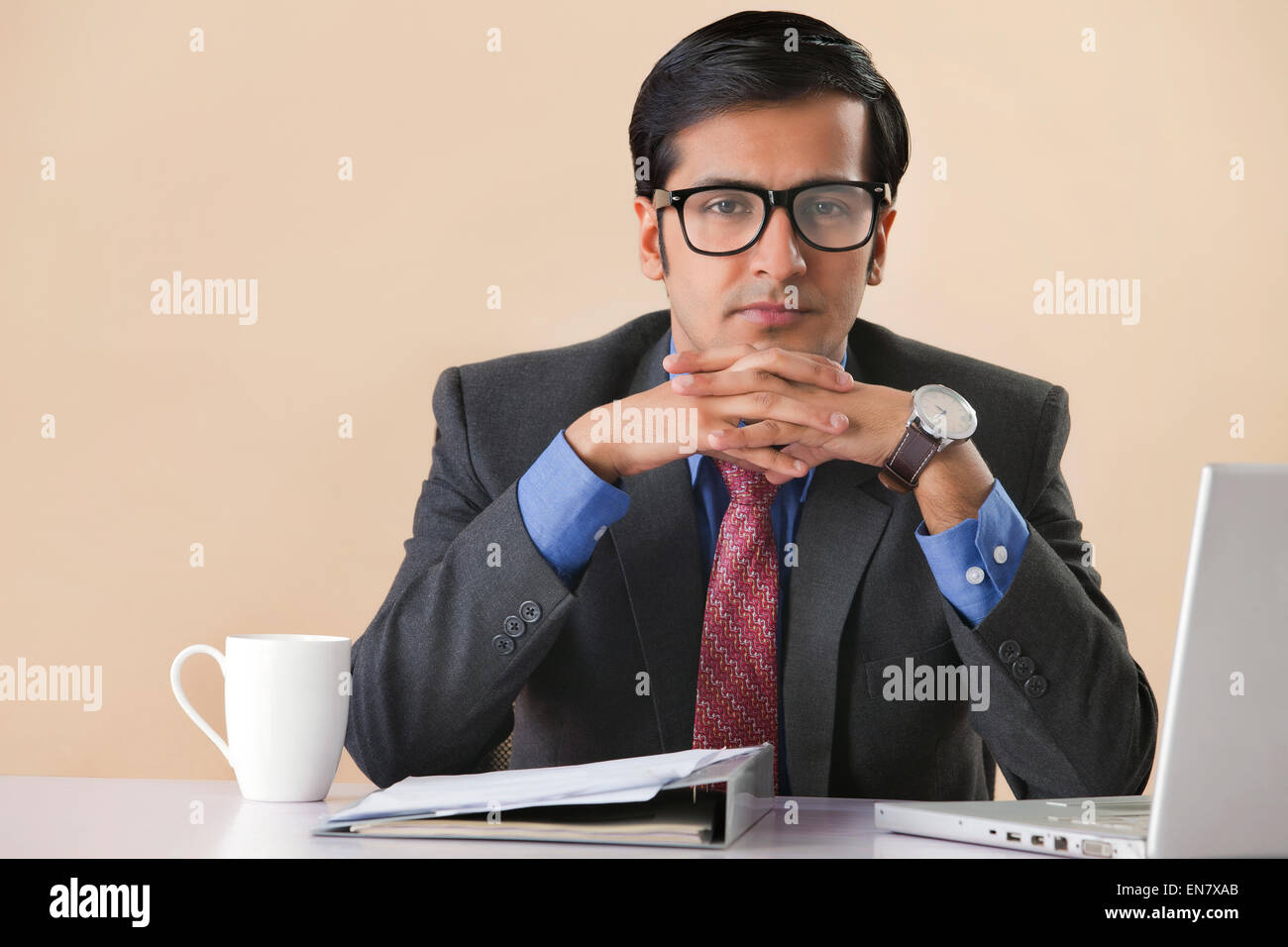 Businessman sitting at computer desk Stock Photo - Alamy