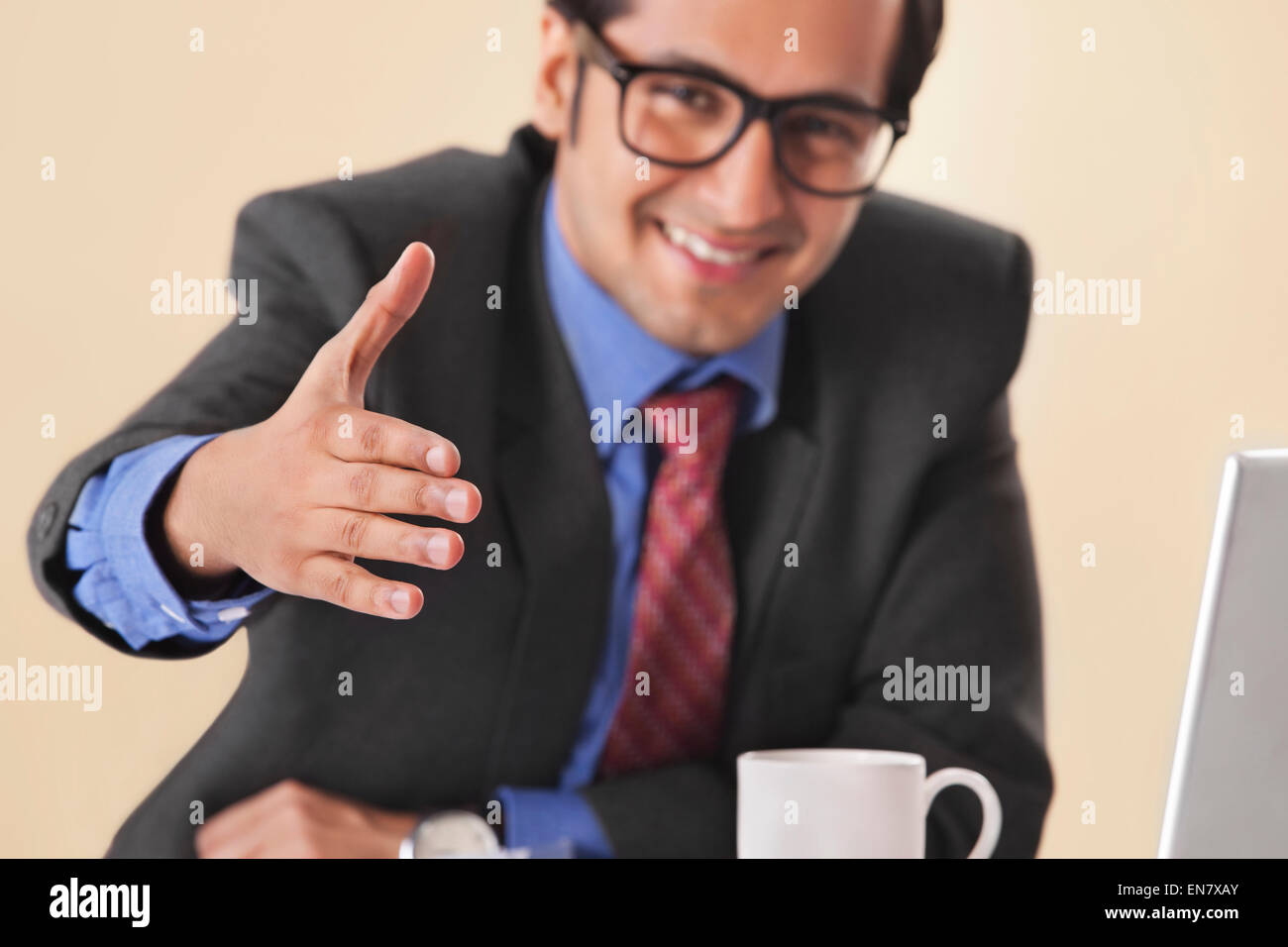 Businessman extending hand for handshake Stock Photo - Alamy